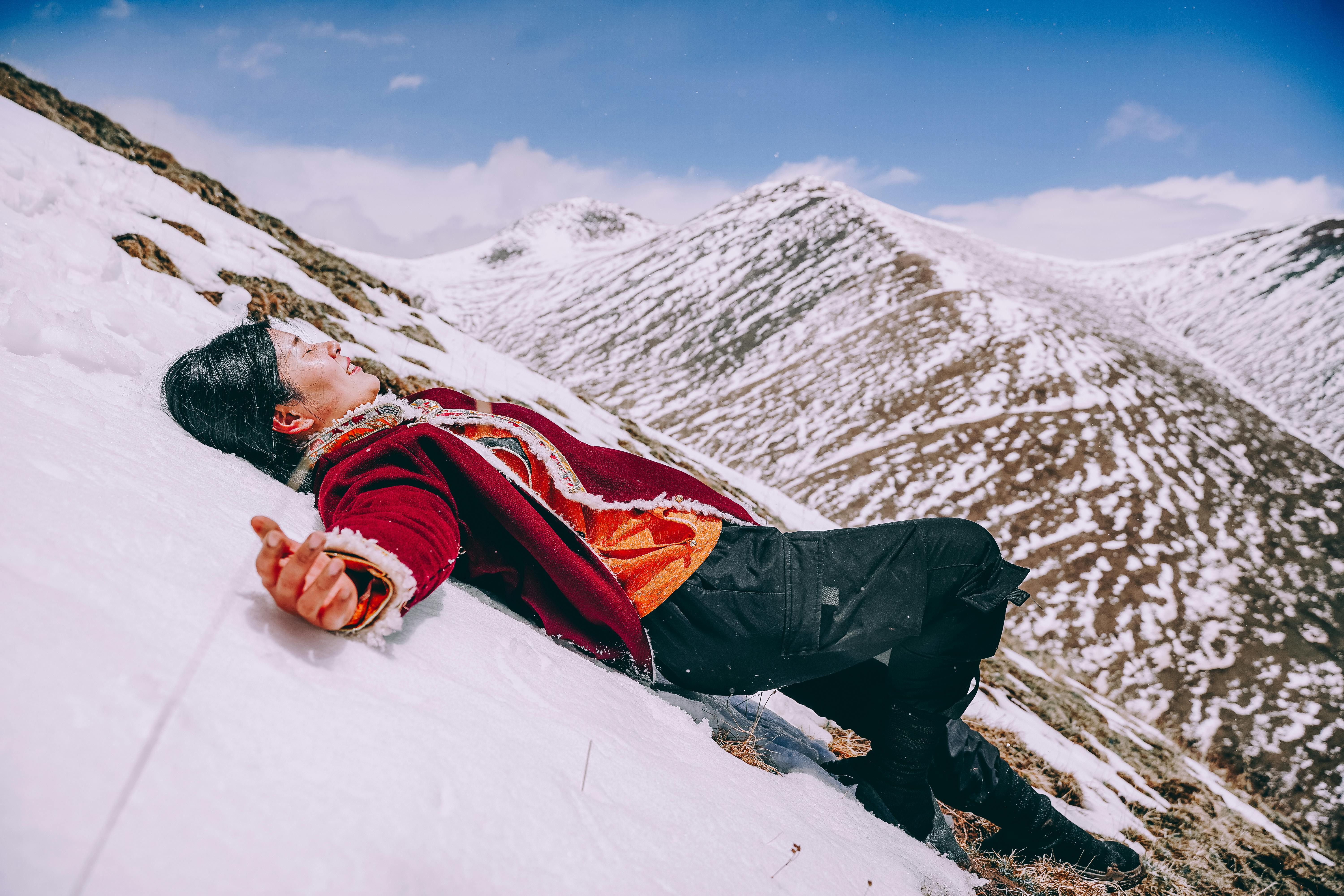 Woman Lying on Back on Snow · Free Stock Photo