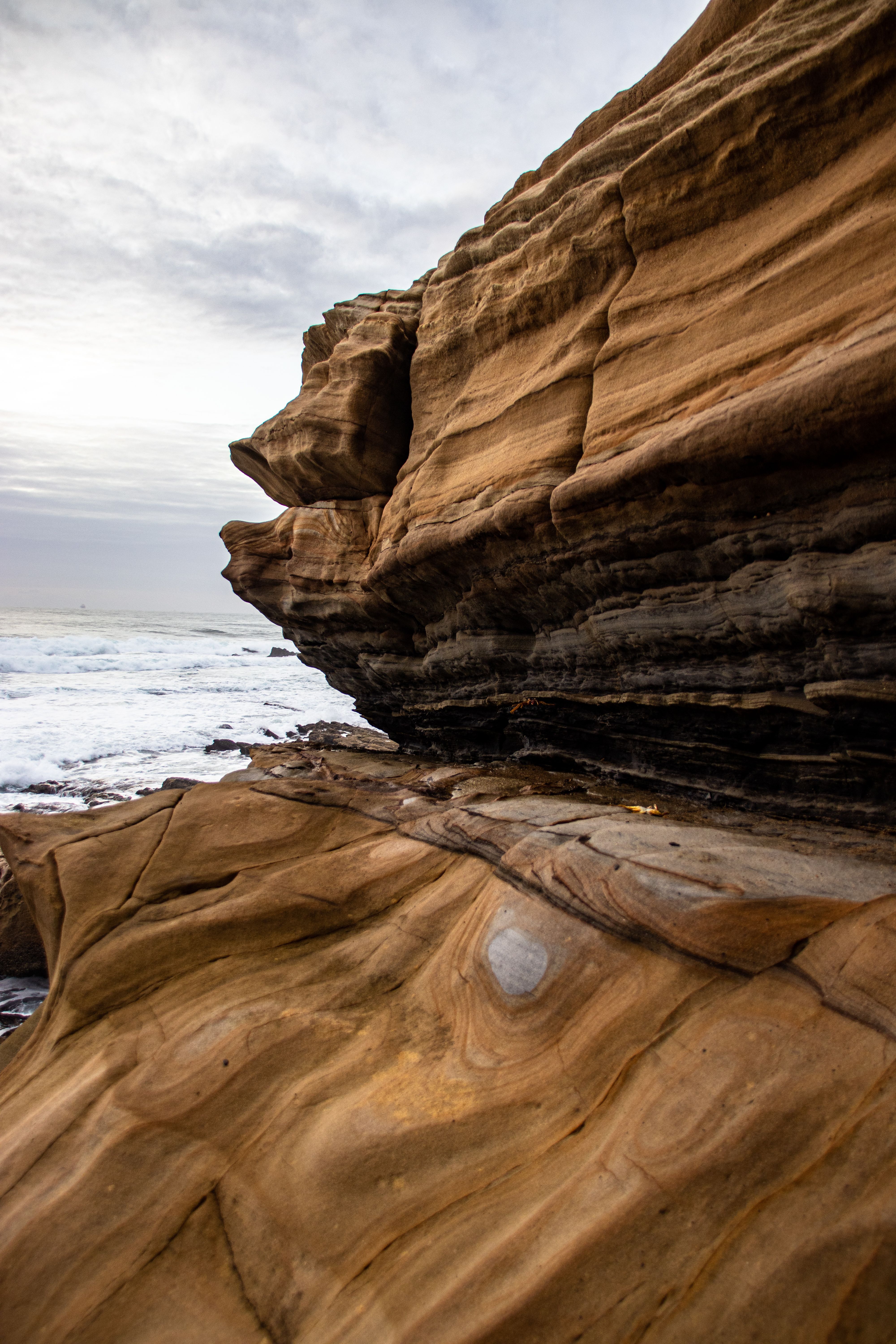 Majestic Coastal Rock Formation Reflecting in Water · Free Stock Photo