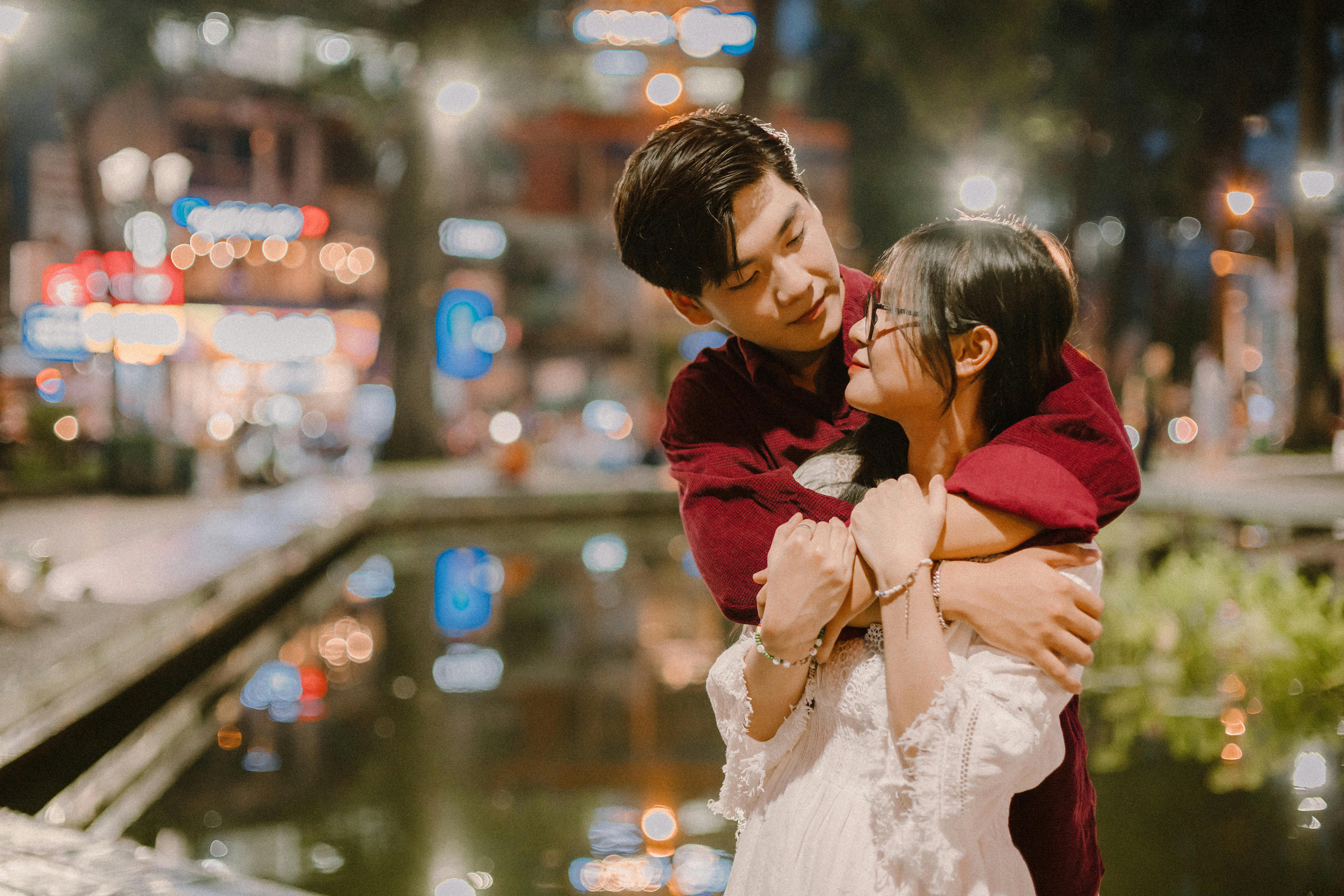 Bubbles Flying over Hugging Couple · Free Stock Photo