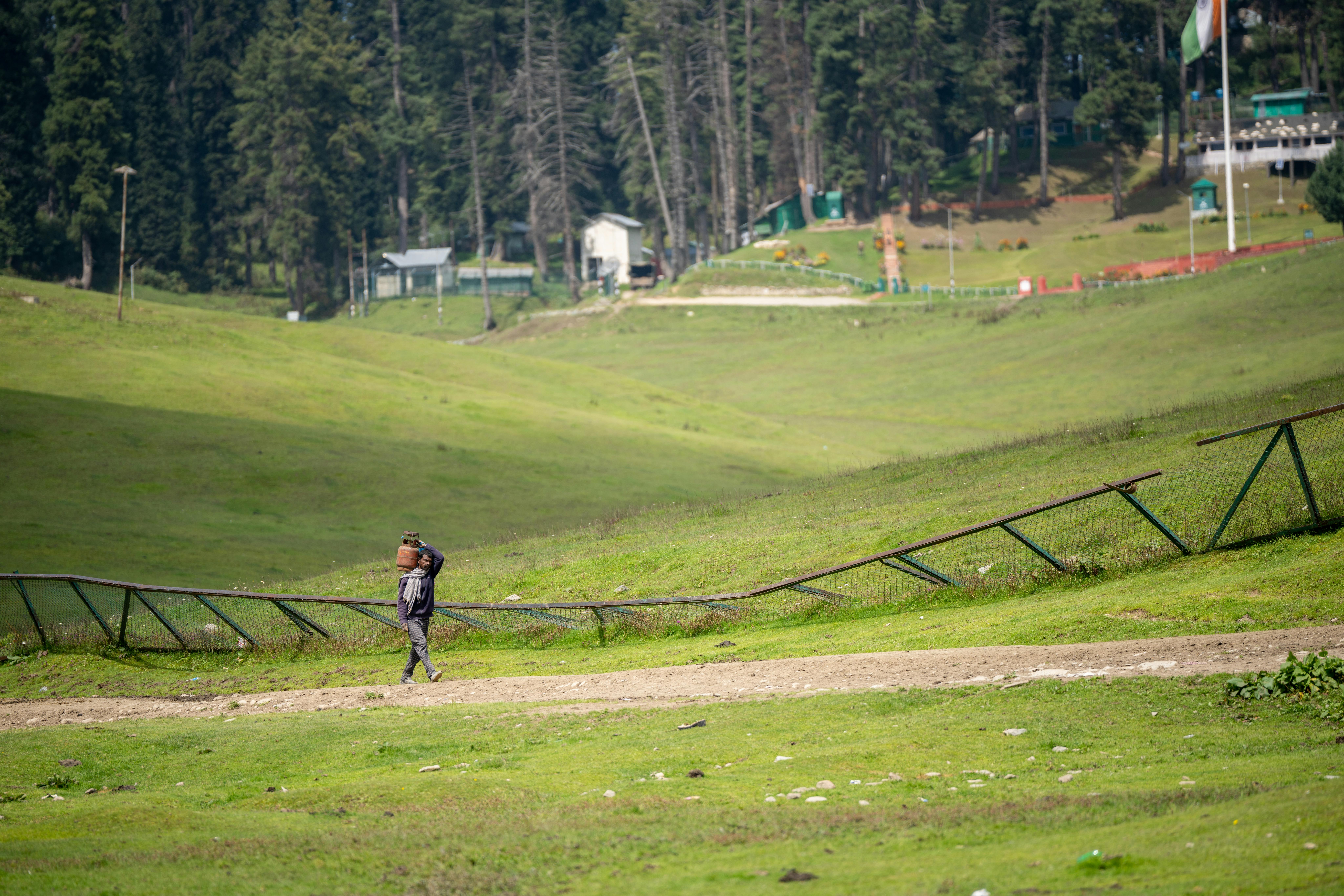 Man Walking on a Path on a Grass Field · Free Stock Photo