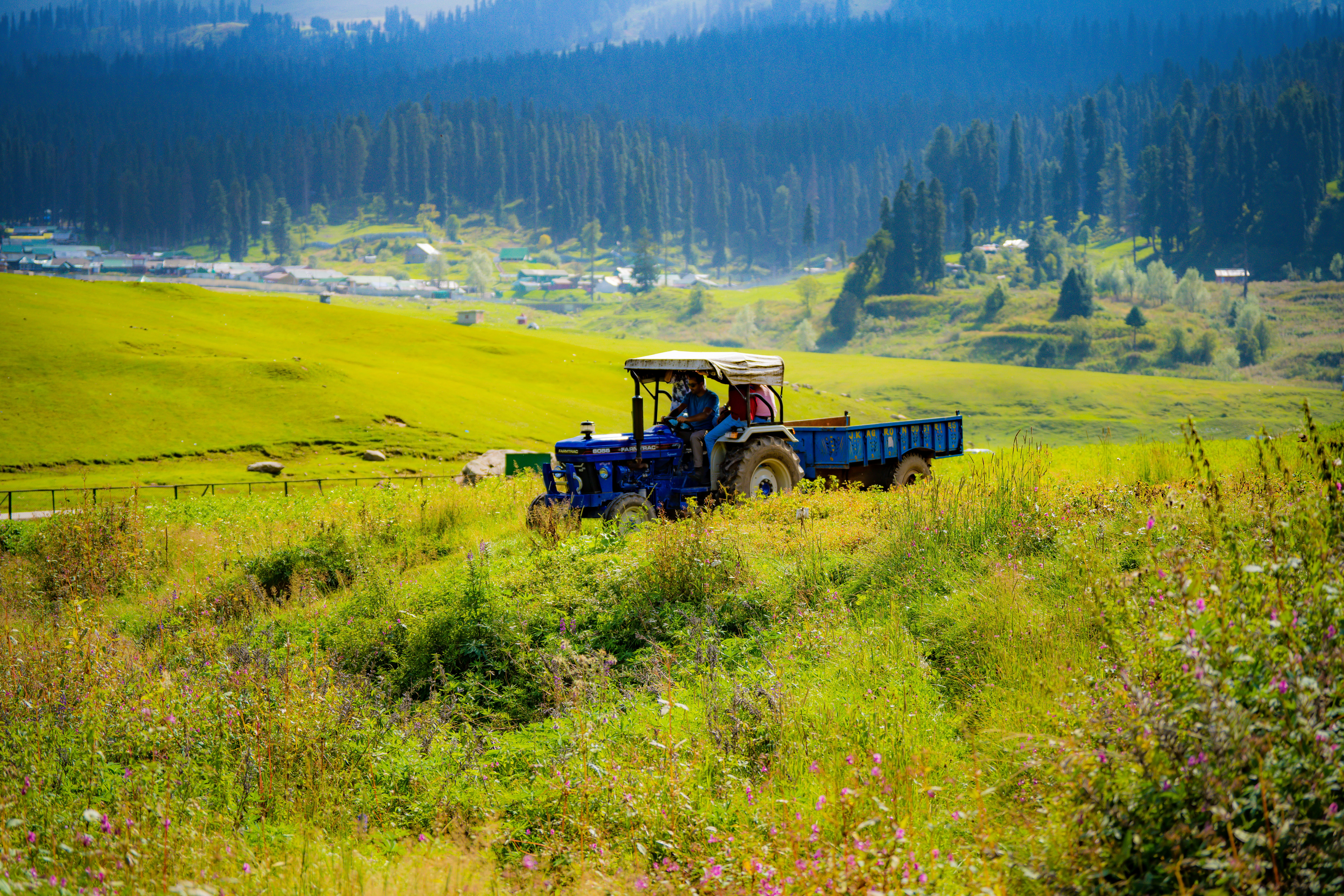 Blue Tractor Moving on the Grass · Free Stock Photo