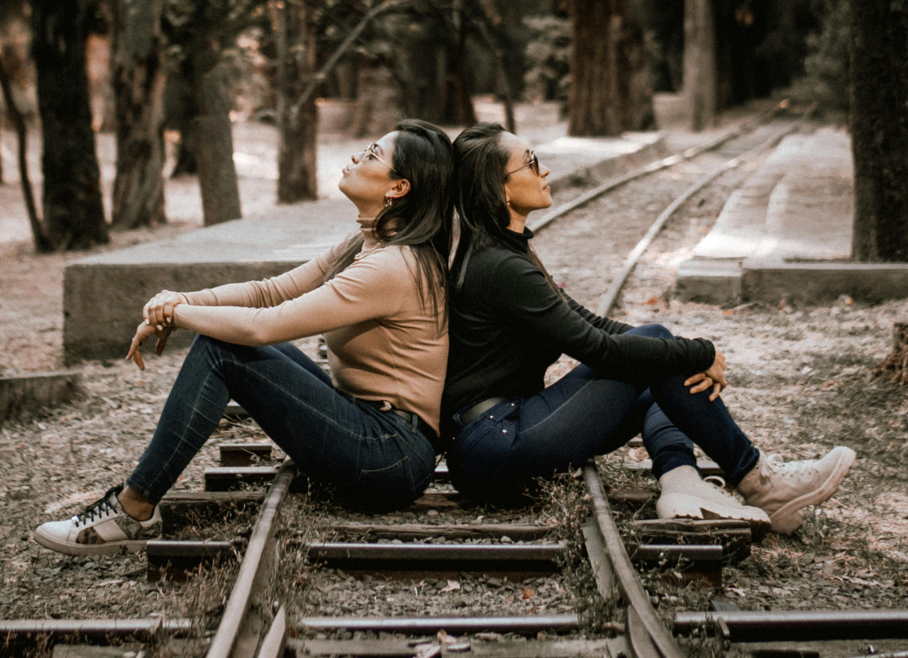Women Sitting on Train Track · Free Stock Photo