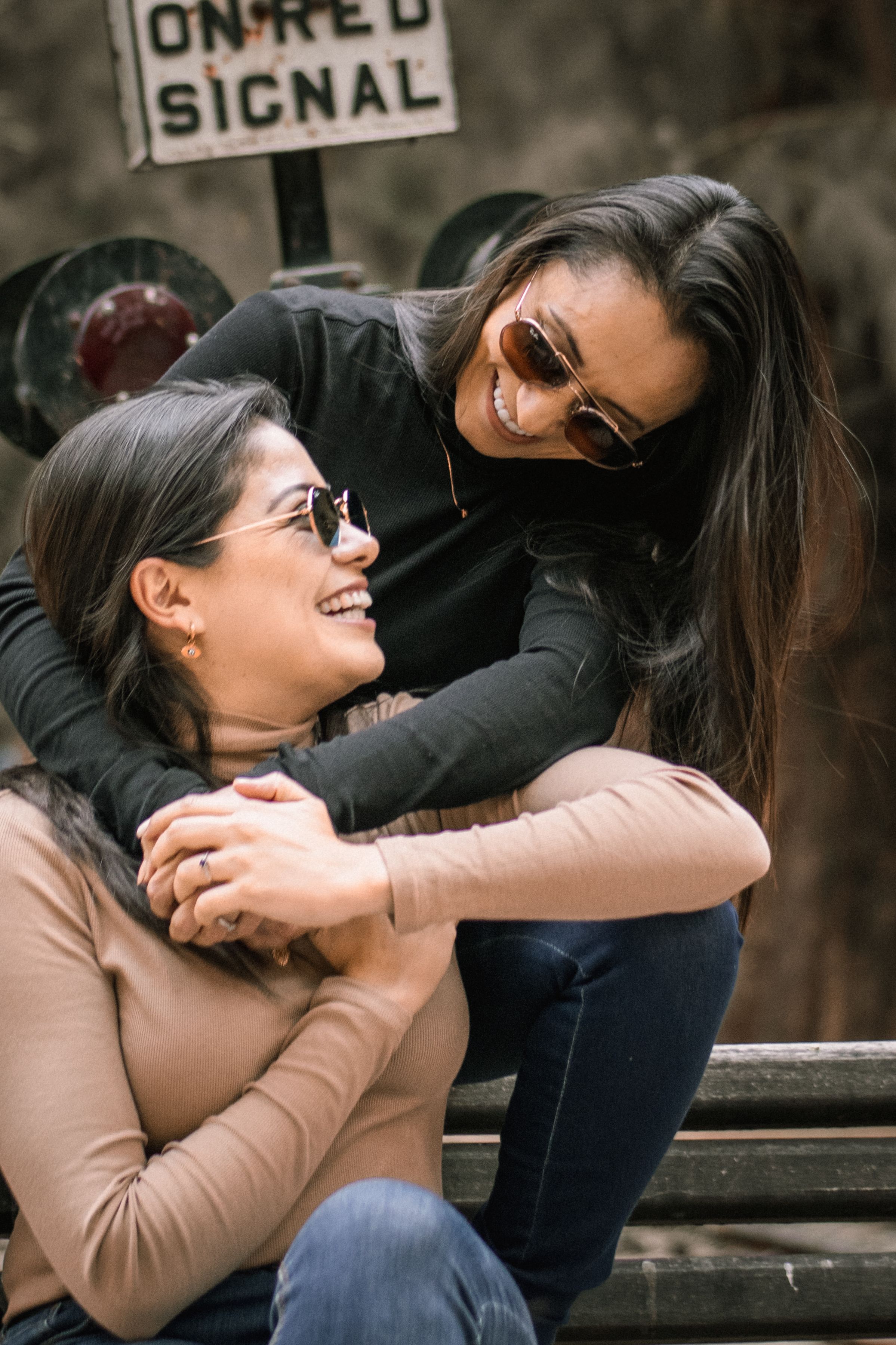 Woman in Black Leather Jacket Hugging Woman in Black Leather Jacket ...