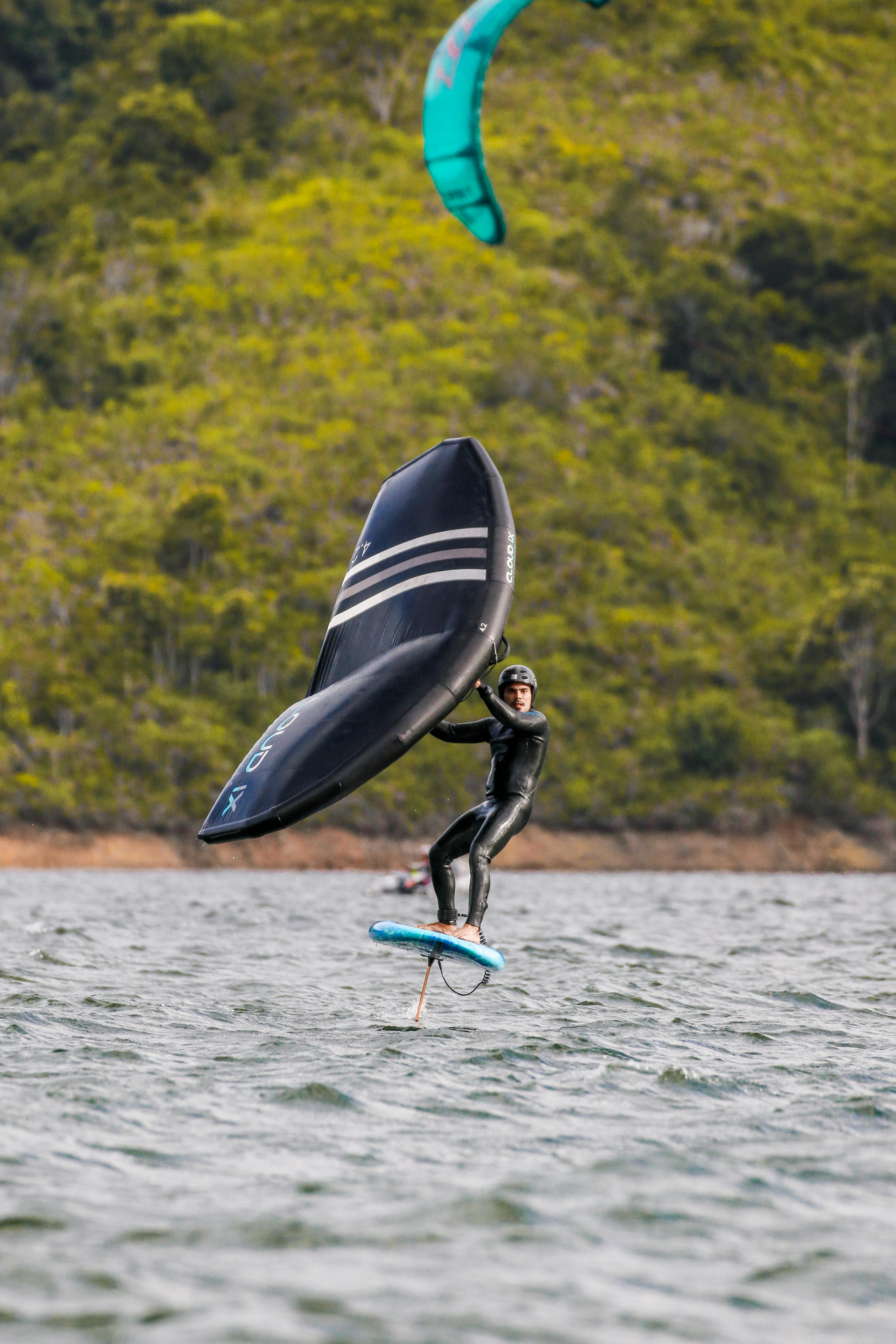A Man Wing Foiling on the Beach · Free Stock Photo
