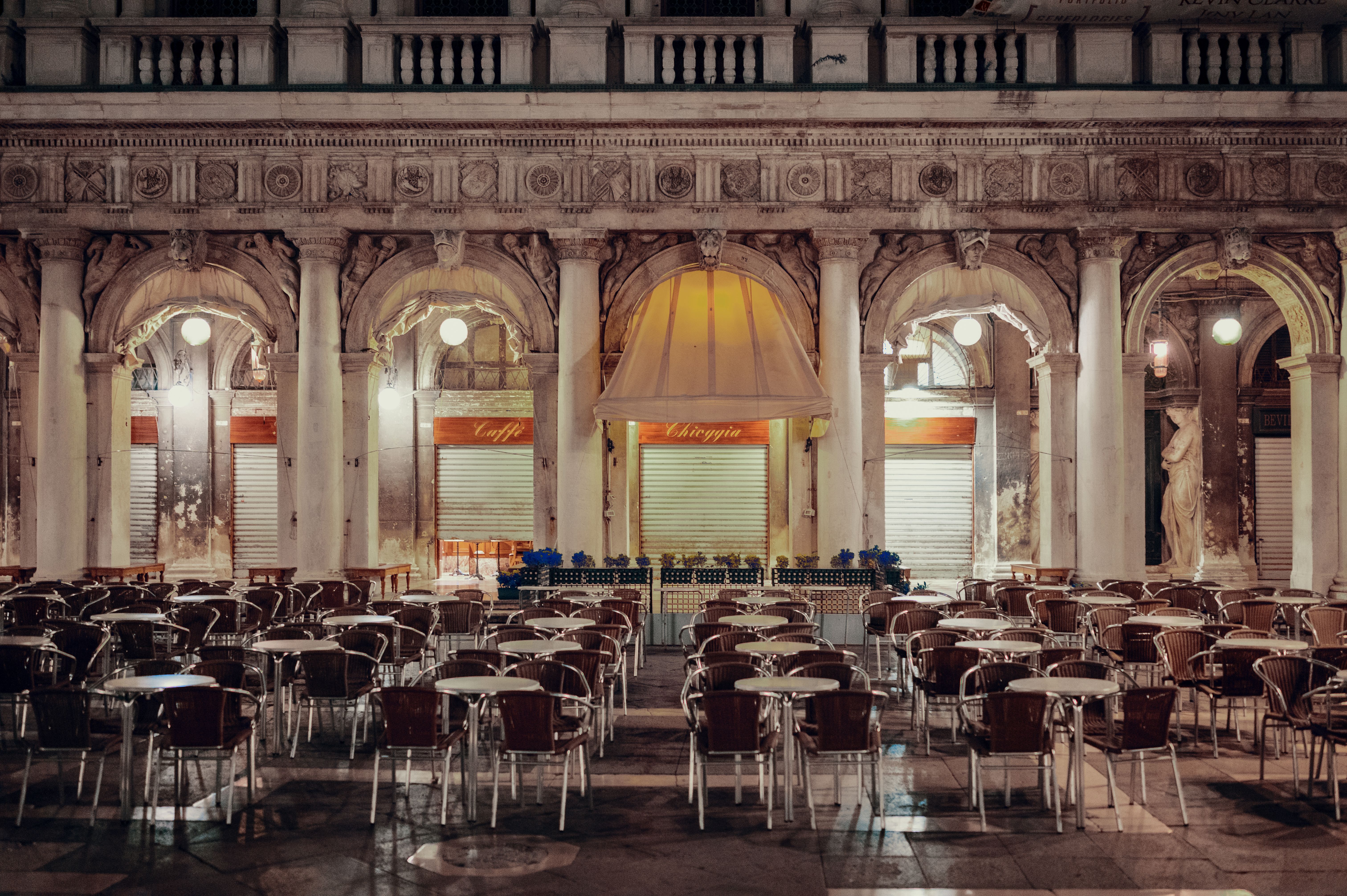 Tables and Chairs In Front of a Building · Free Stock Photo