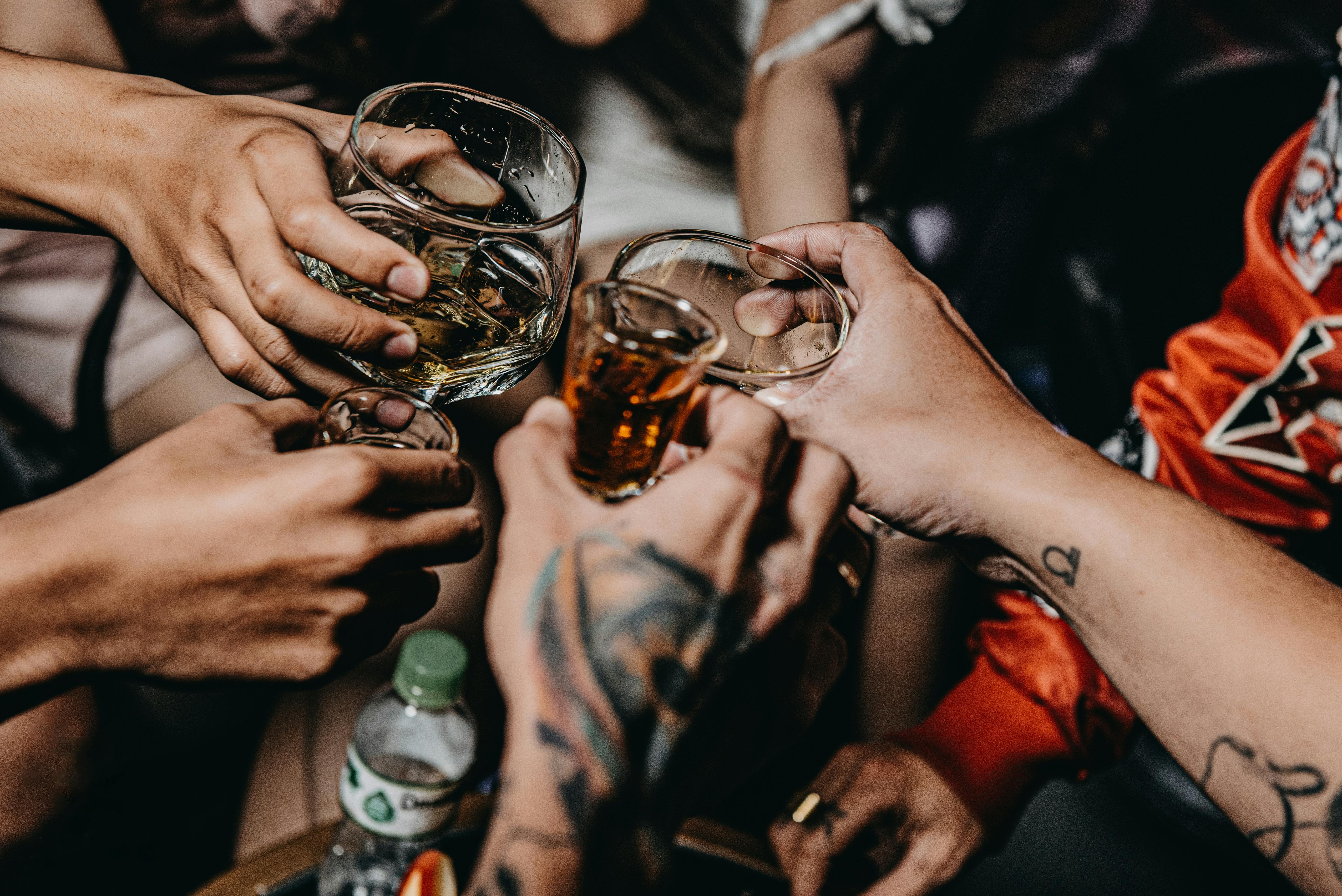Photograph of Hands Doing a Toast with Their Drinks · Free Stock Photo