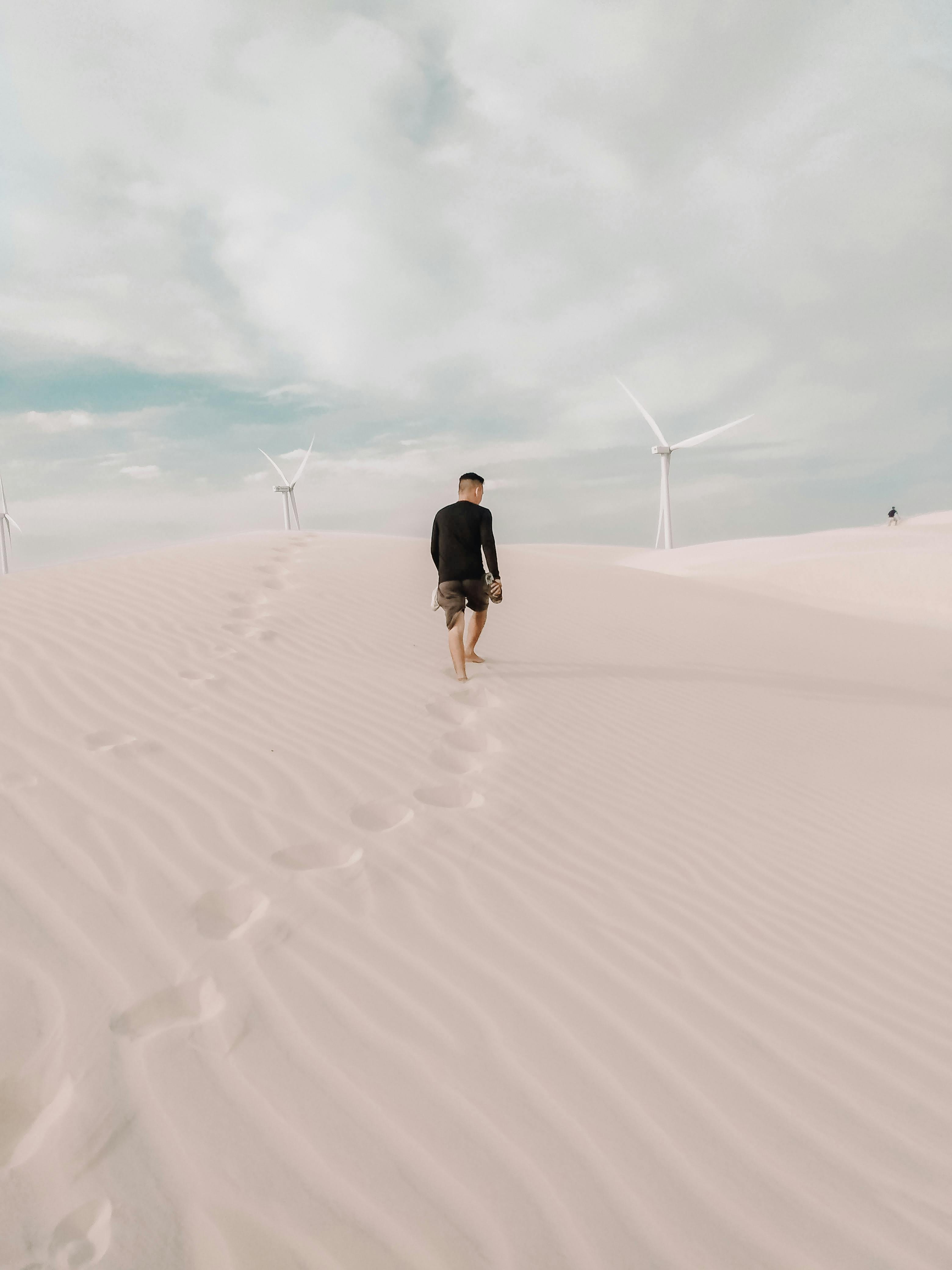 Back View of a Man Walking on the Dunes · Free Stock Photo
