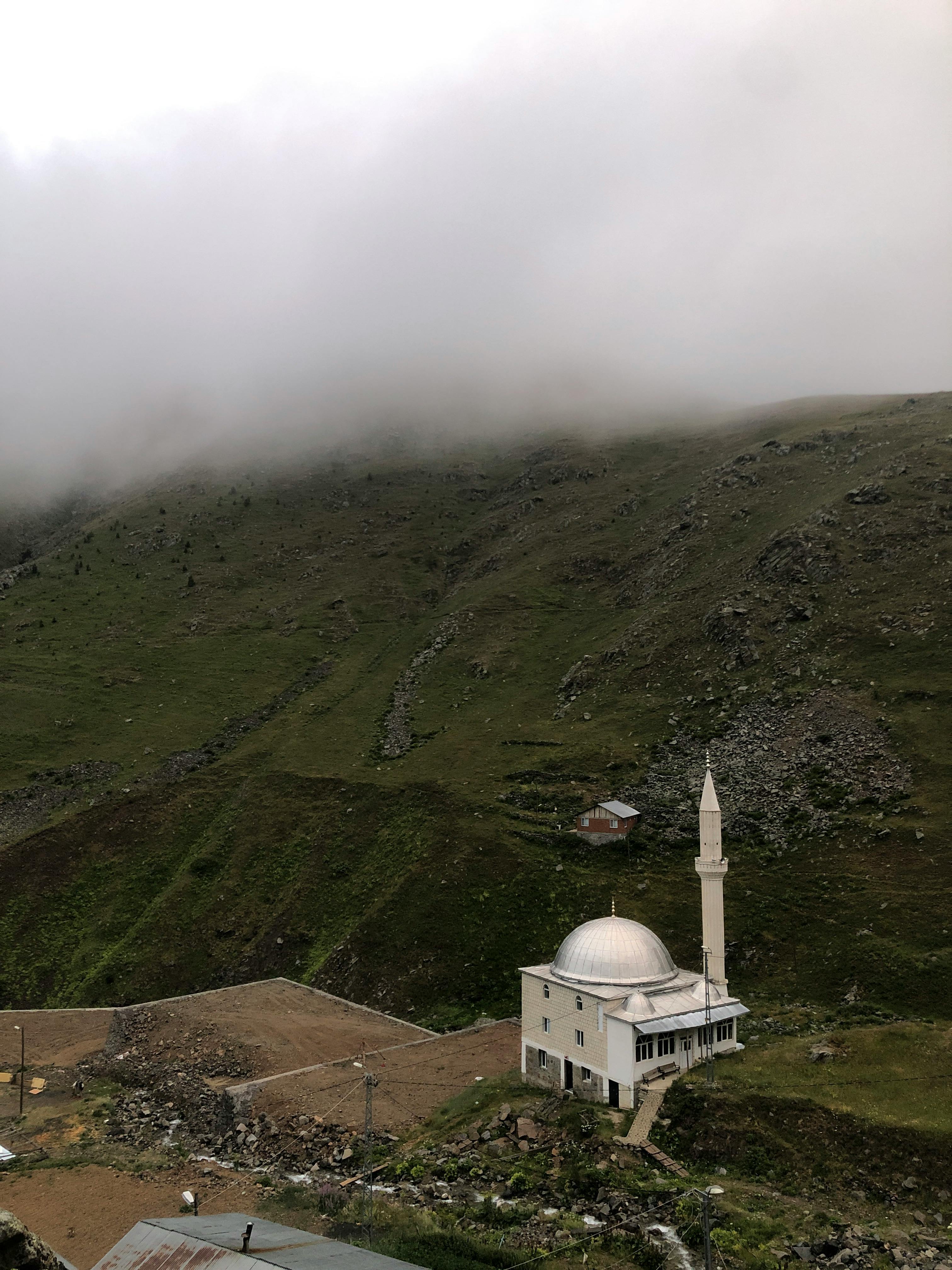 Aerial View of a Mosque in a Mountain Valley · Free Stock Photo