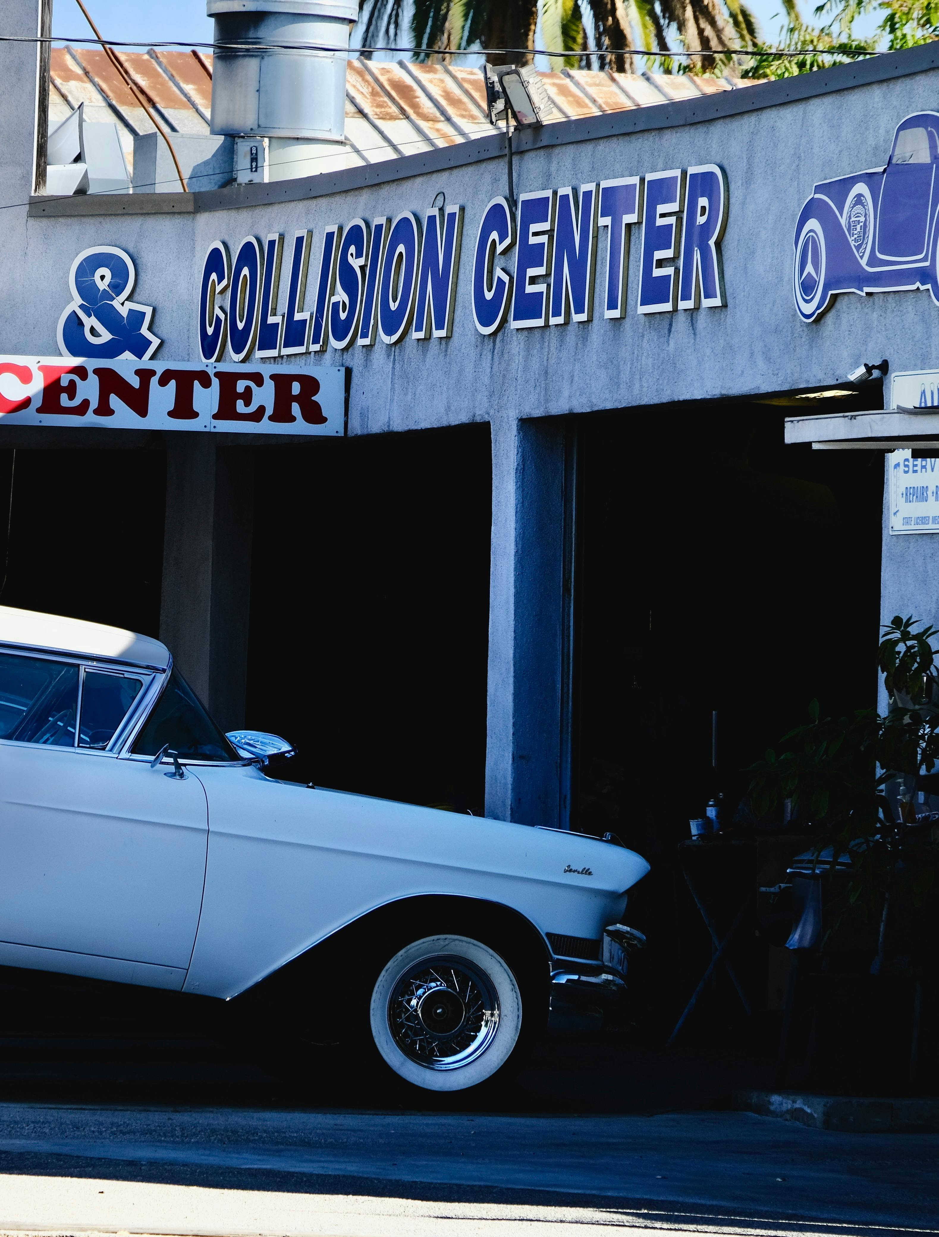 White Classic Car Parked Beside White Building · Free Stock Photo