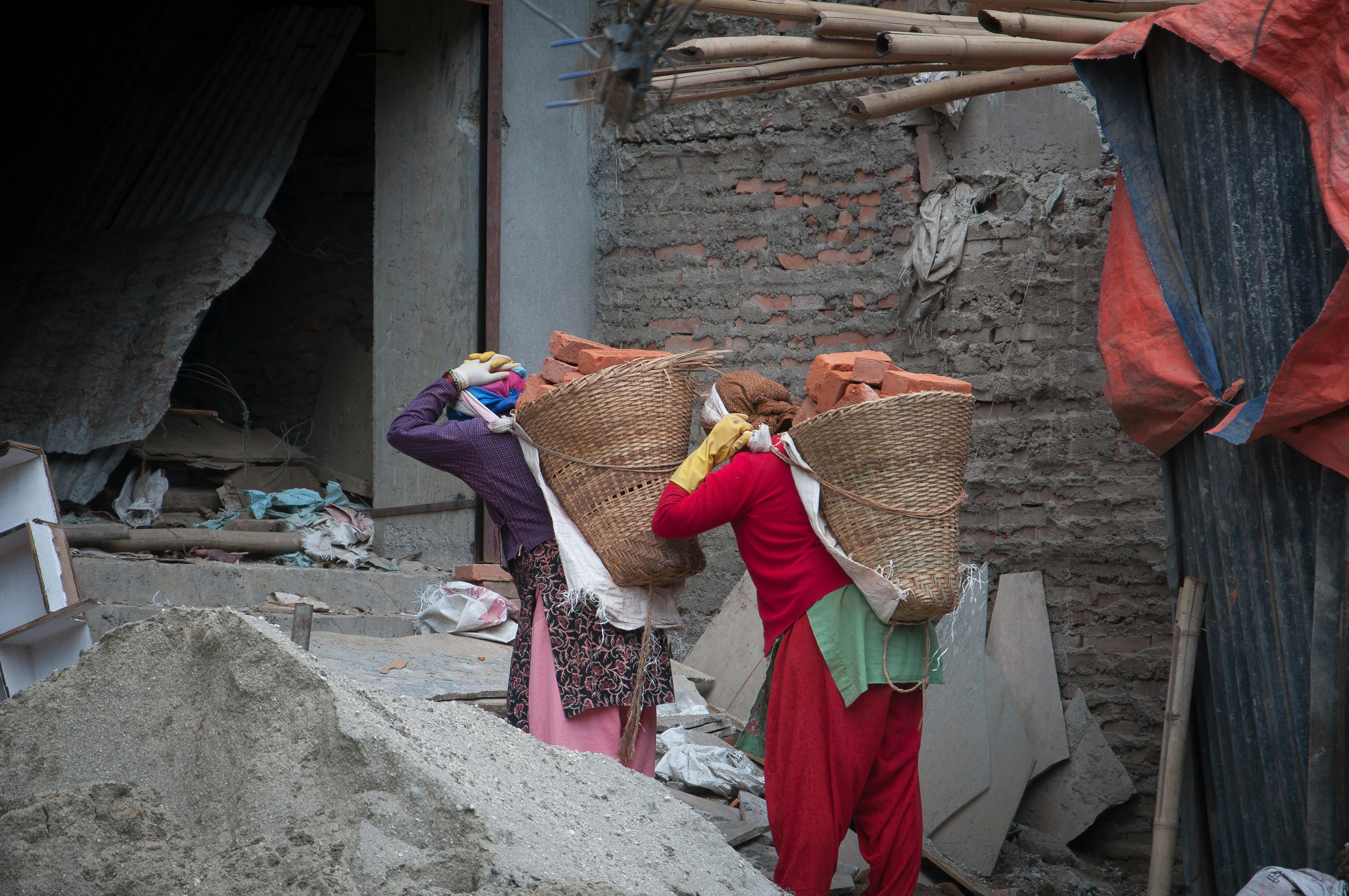 A Person Walking while Carrying a Pylon · Free Stock Photo