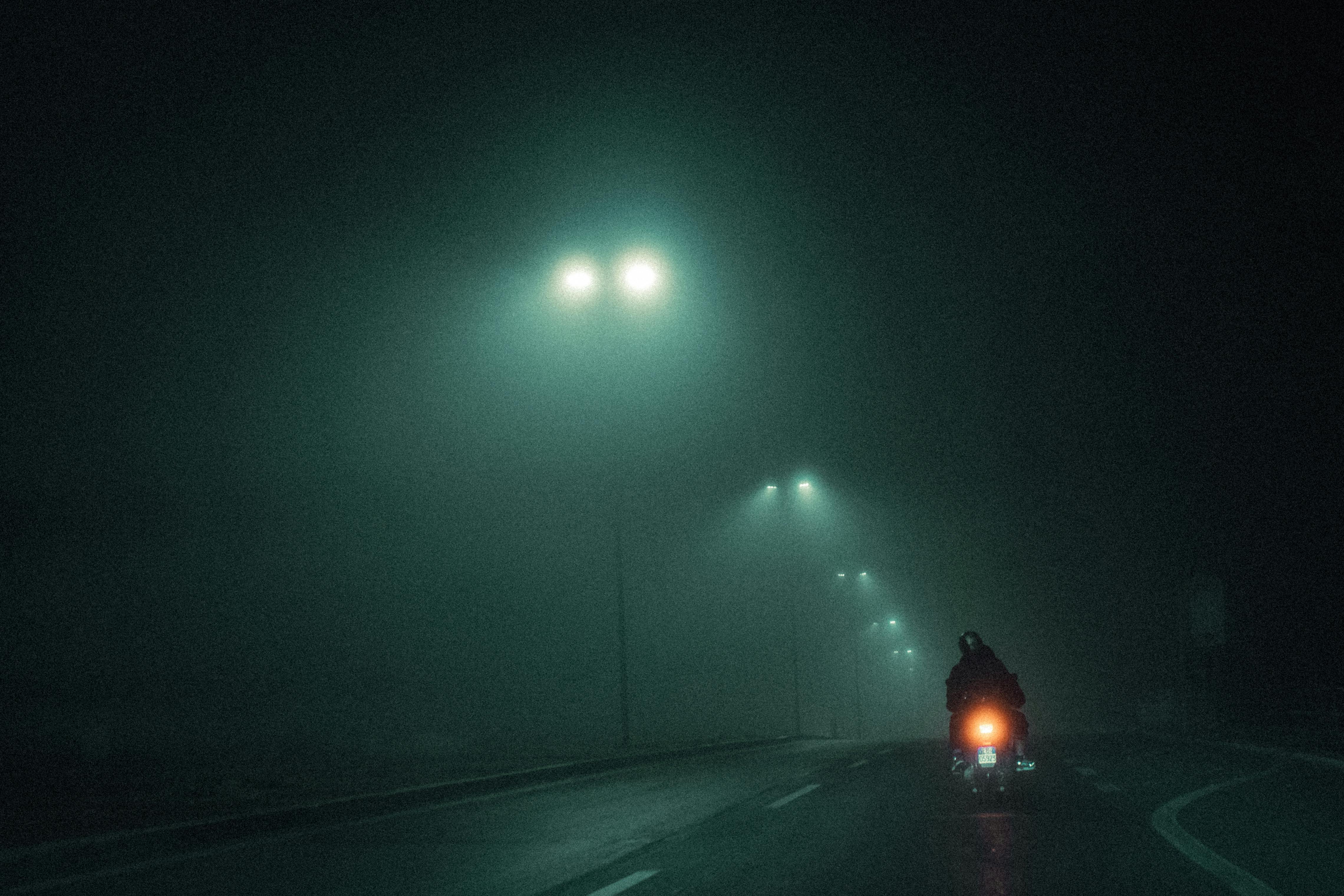 Person on Motorbike Riding in Fog on Road at Night · Free Stock Photo