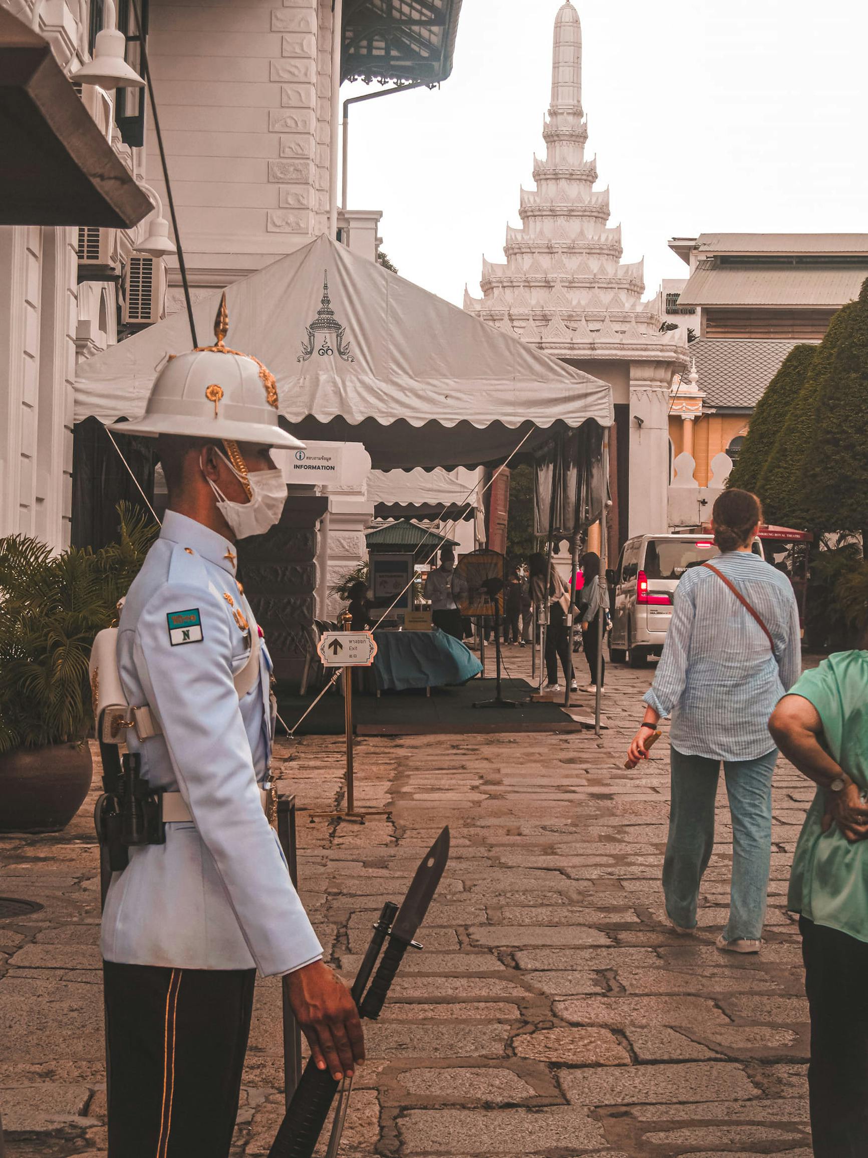 Security Guard Walking on Street near Building in City · Free Stock Photo