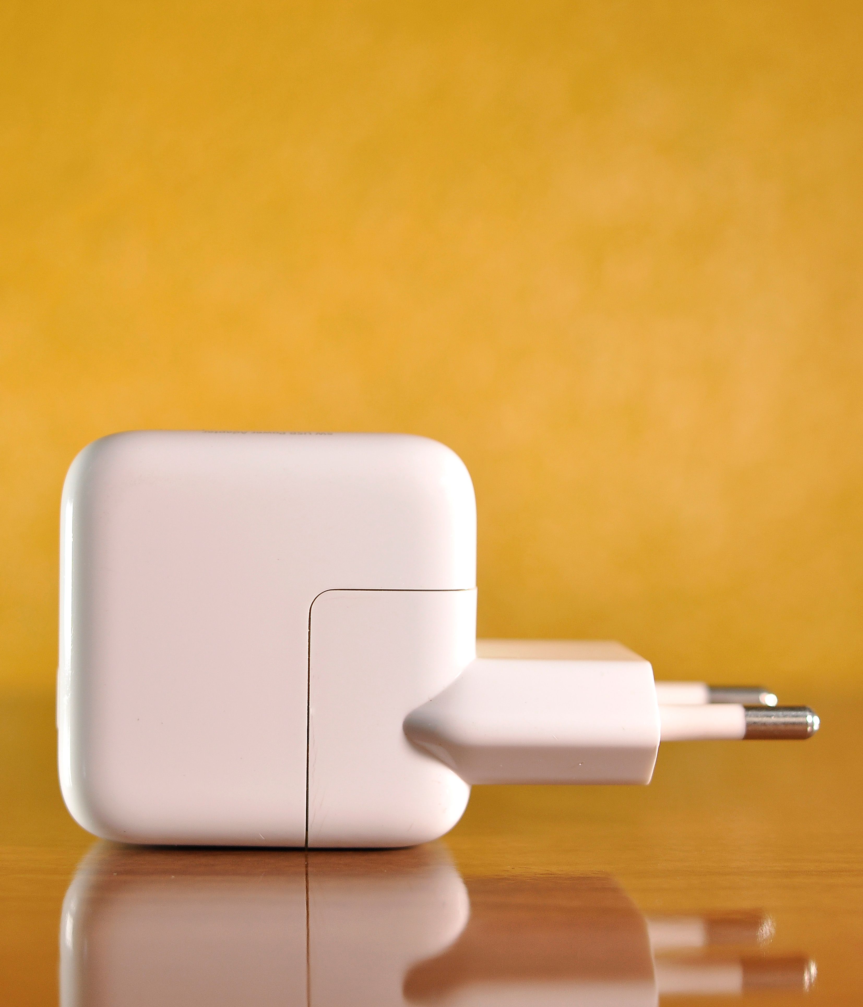 Many chargers are connected to an electrical outlet on a white ...