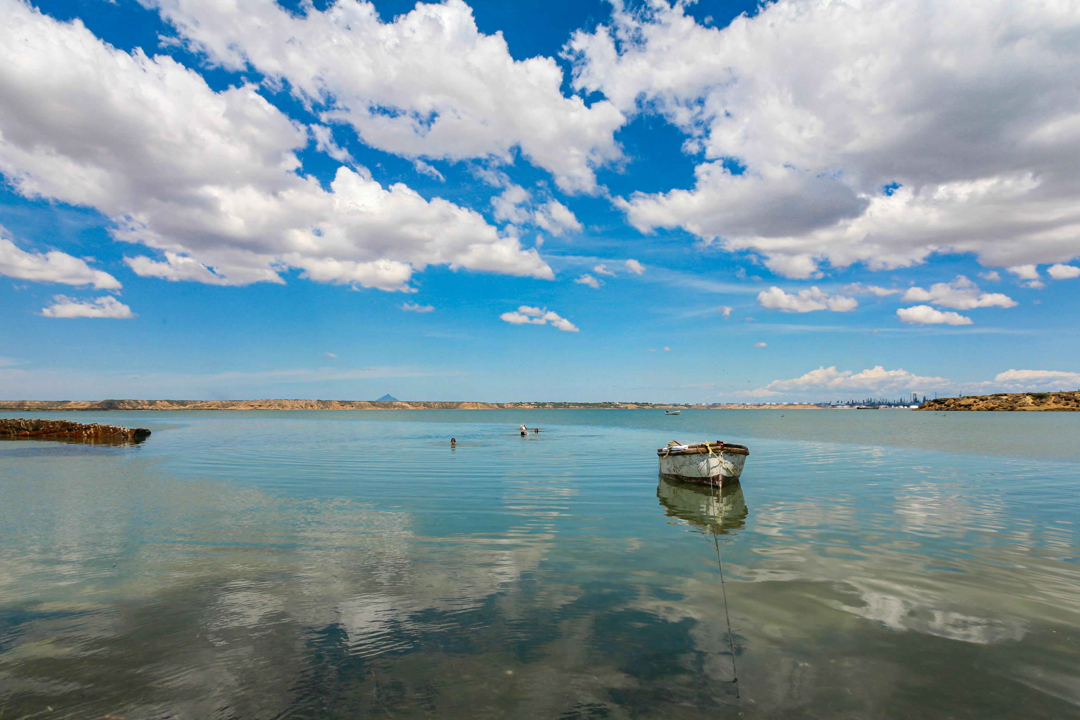 Boat on Sea Under Blue Sky and White Clouds · Free Stock Photo
