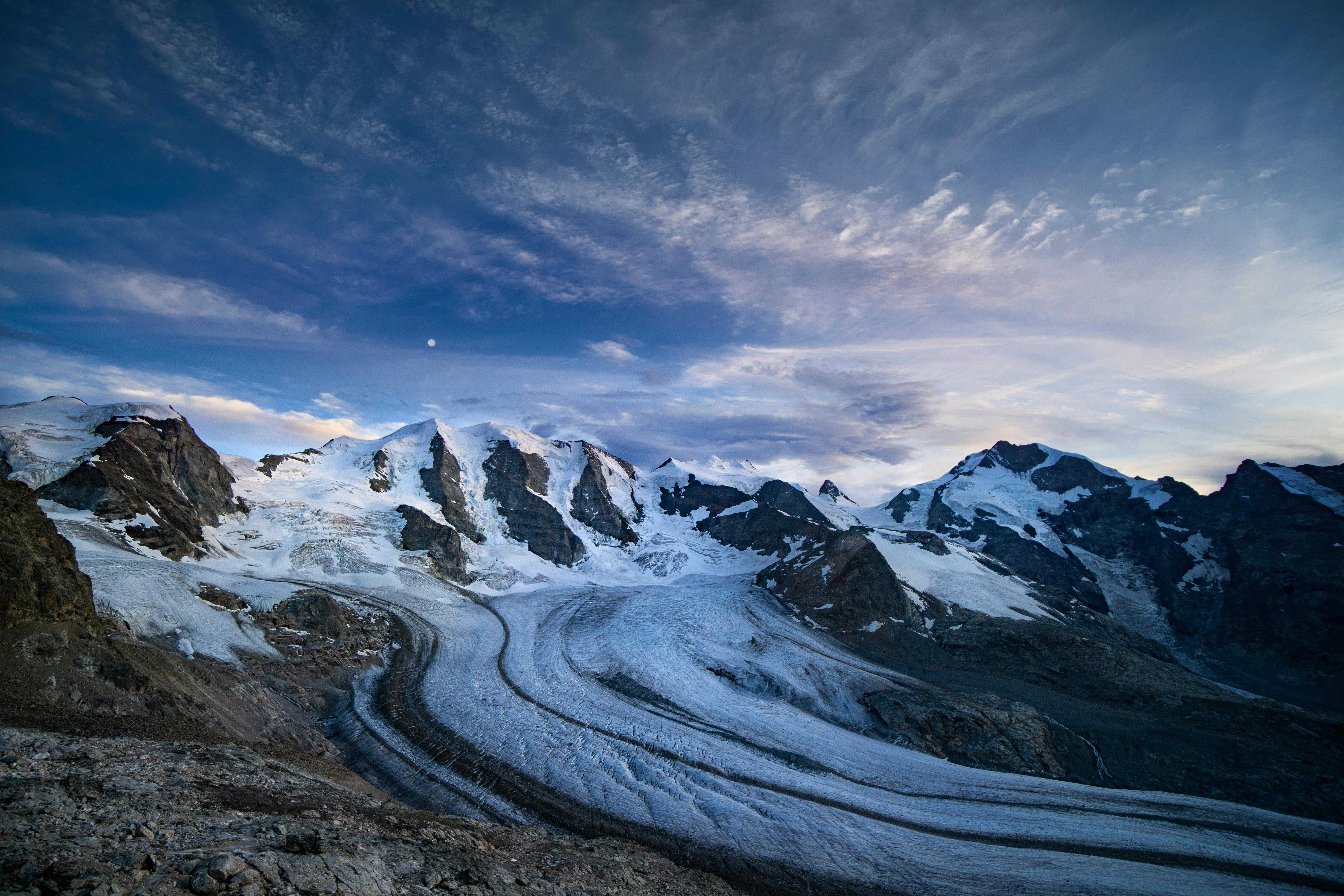 An Aerial Photography of Snow Covered Mountains Under the Blue Sky and ...