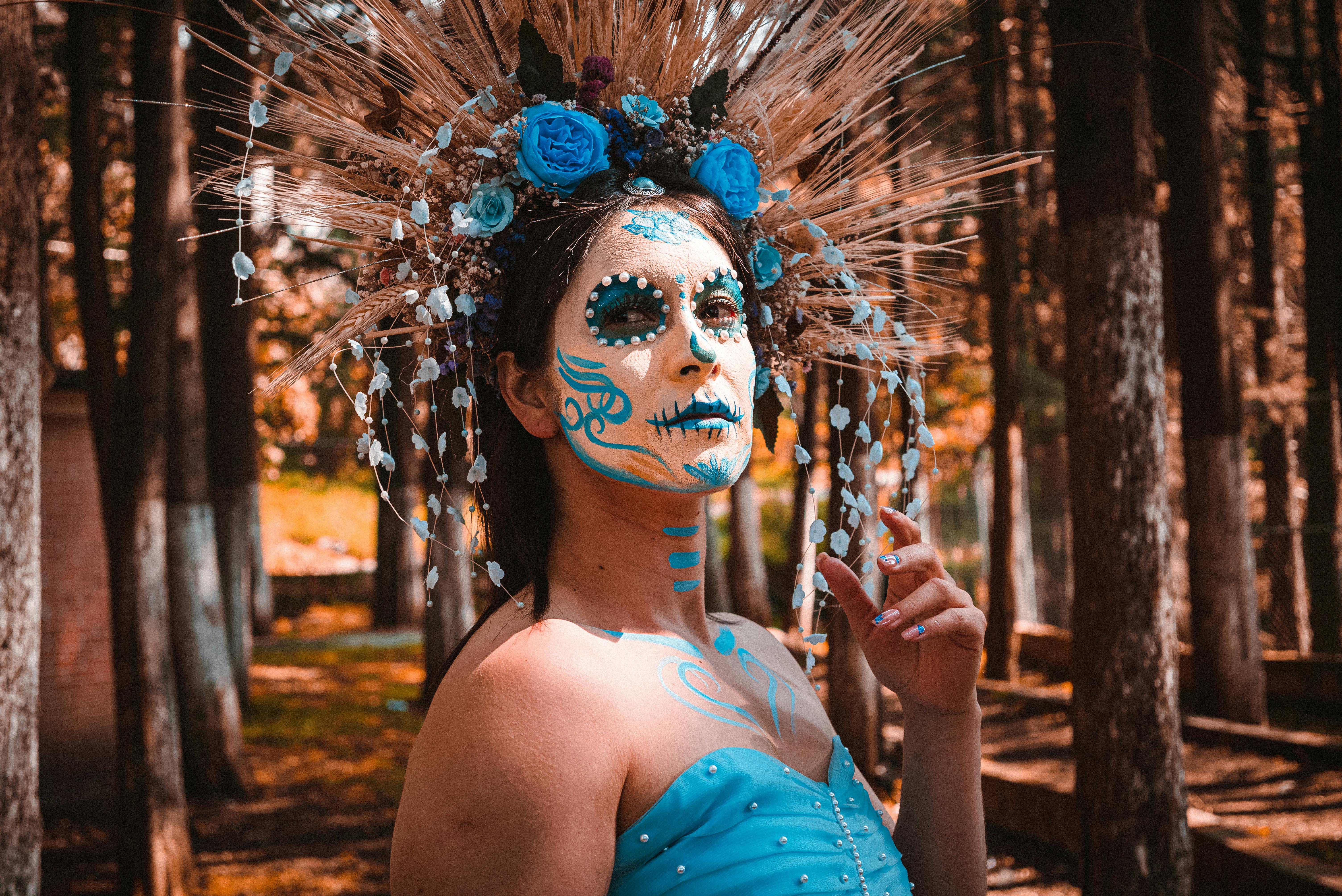 A Woman Wearing a Blue Face Art · Free Stock Photo