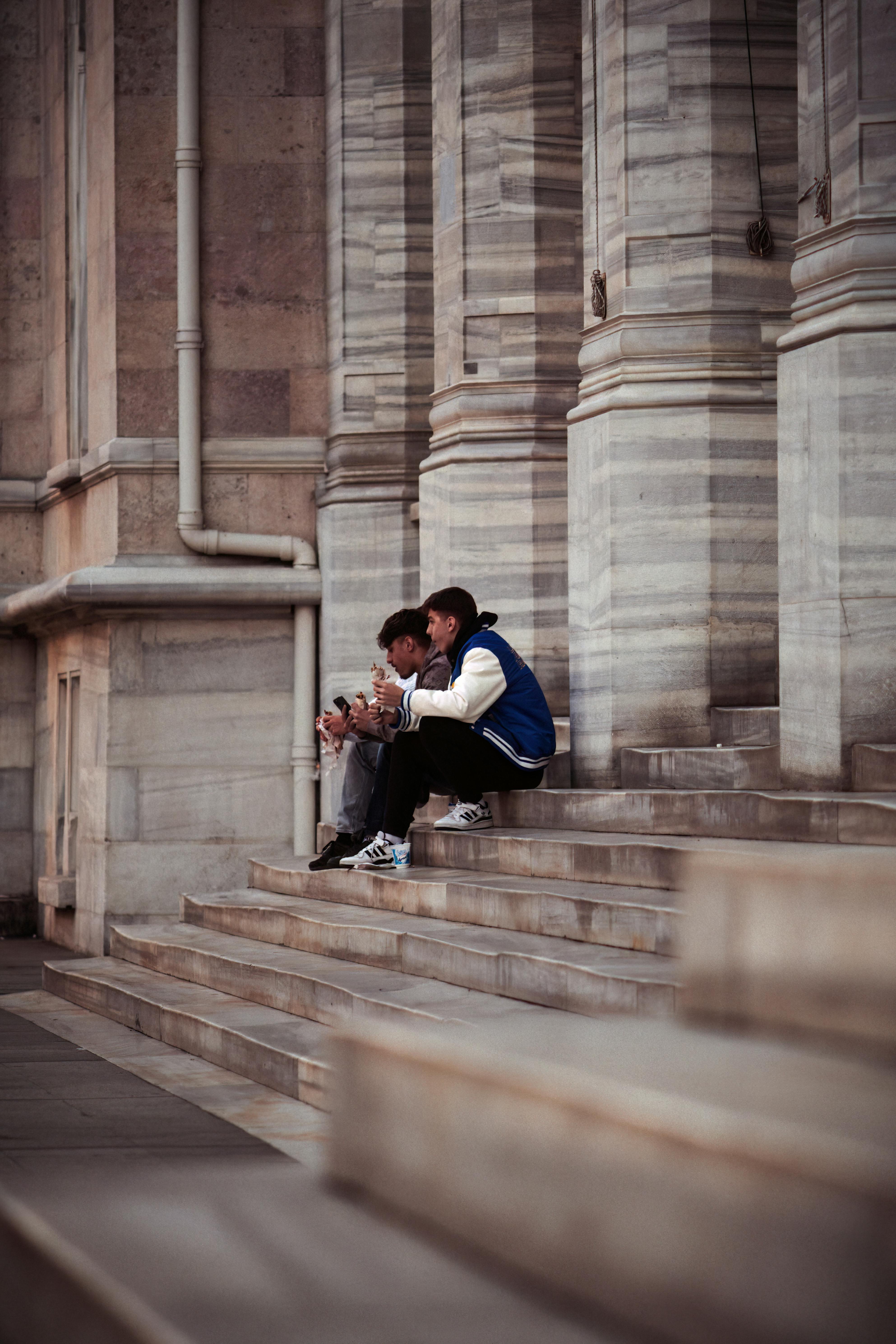 Men Sitting on Concrete Stairs · Free Stock Photo