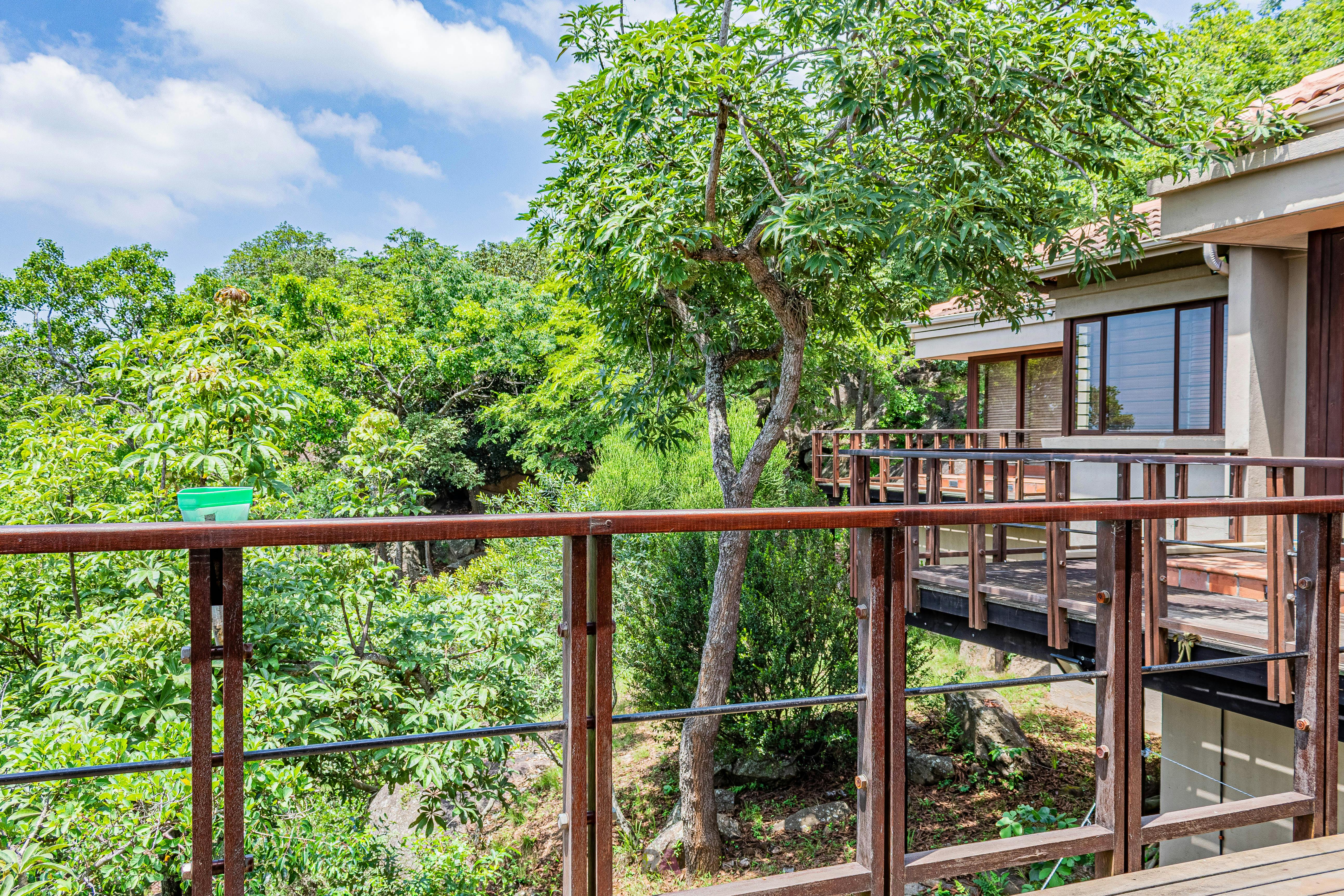 Wooden Balcony and Railing Overlooking Front Yard of a Family Home ...
