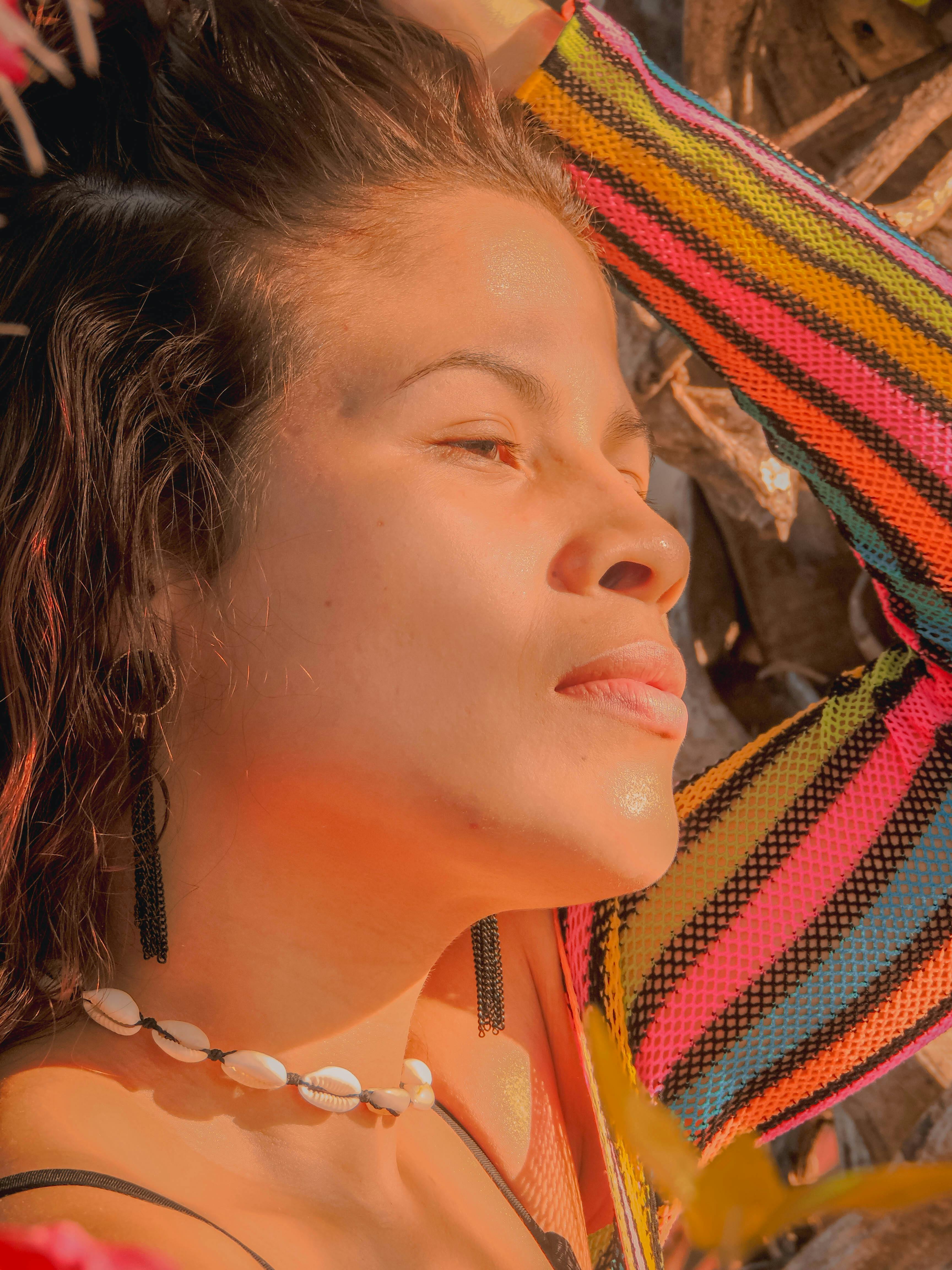 A Close-up Shot of a Woman Wearing Shell Necklace · Free Stock Photo