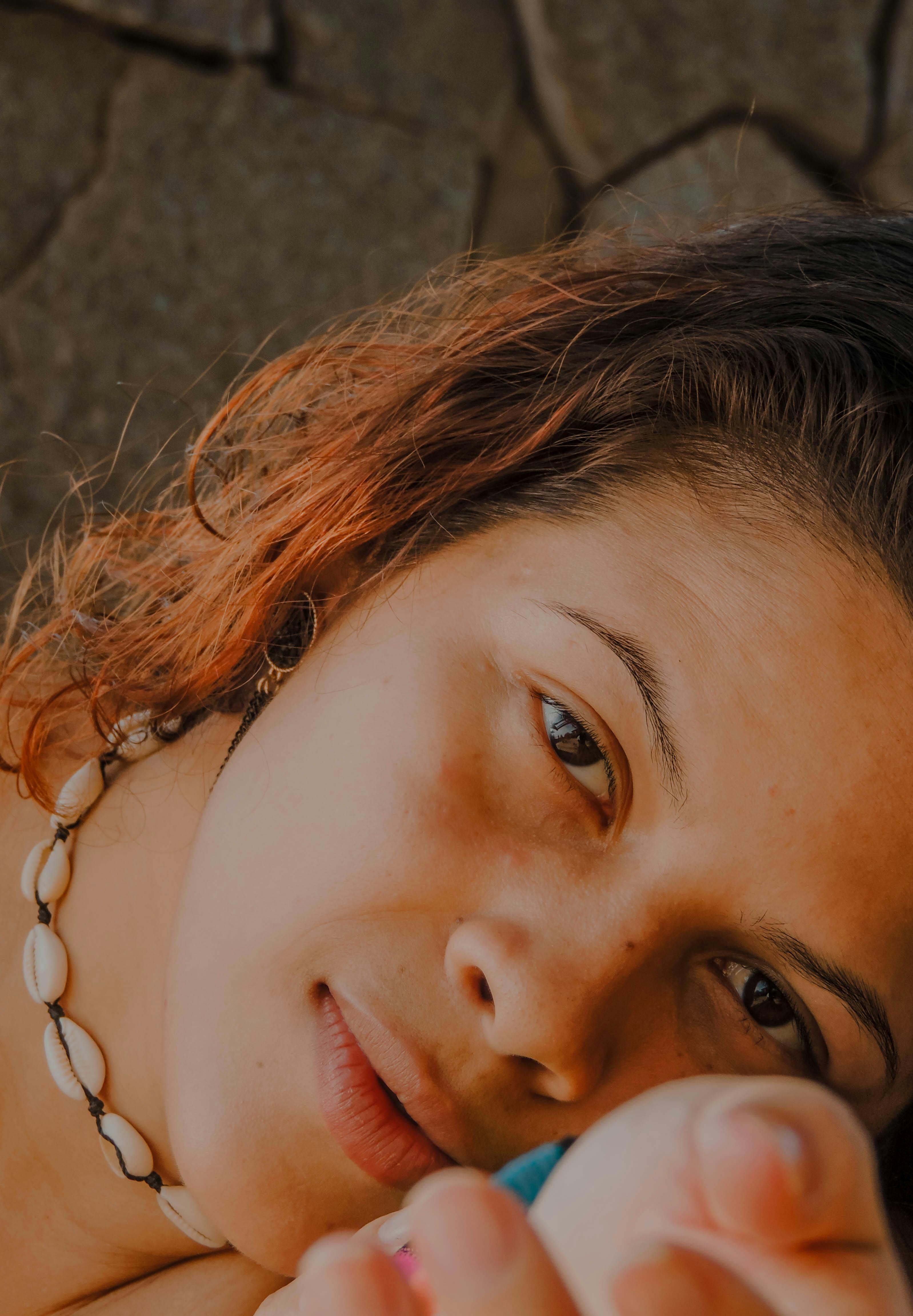 A Close-up Shot of a Woman Wearing Shell Necklace · Free Stock Photo