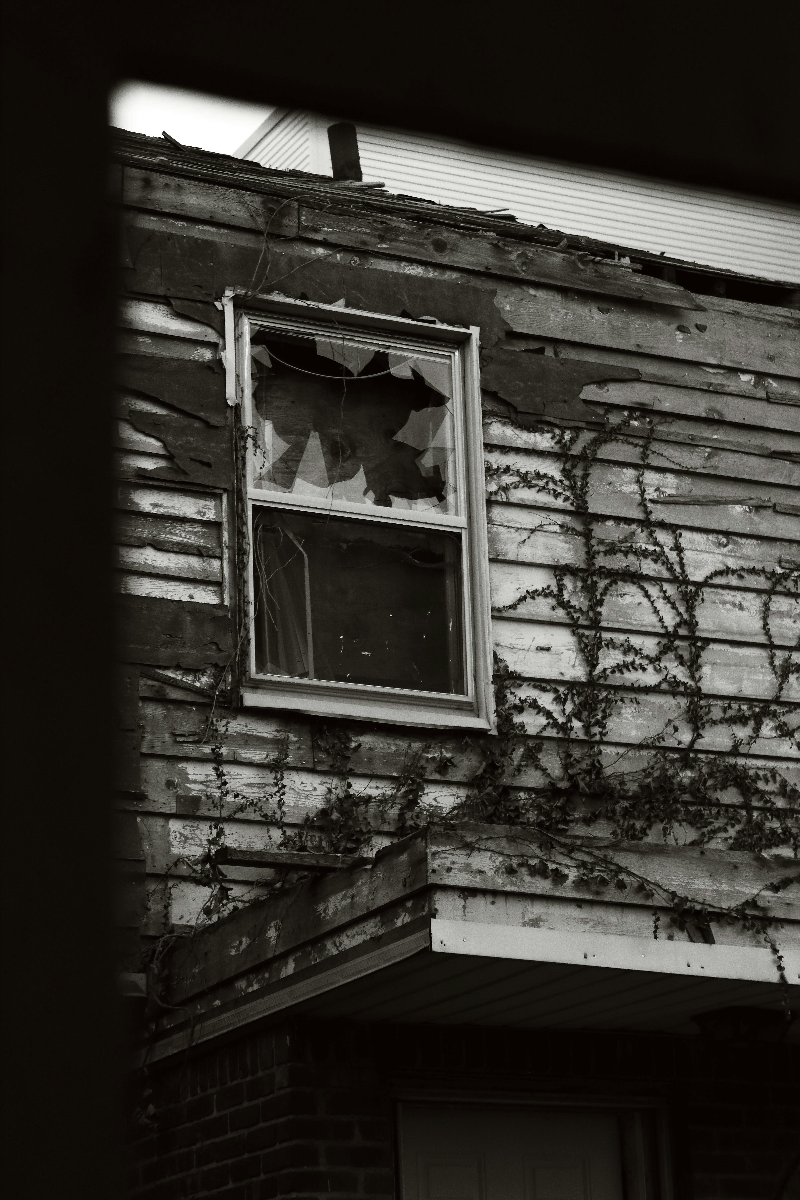 An Abandoned House with Broken Wooden Window · Free Stock Photo