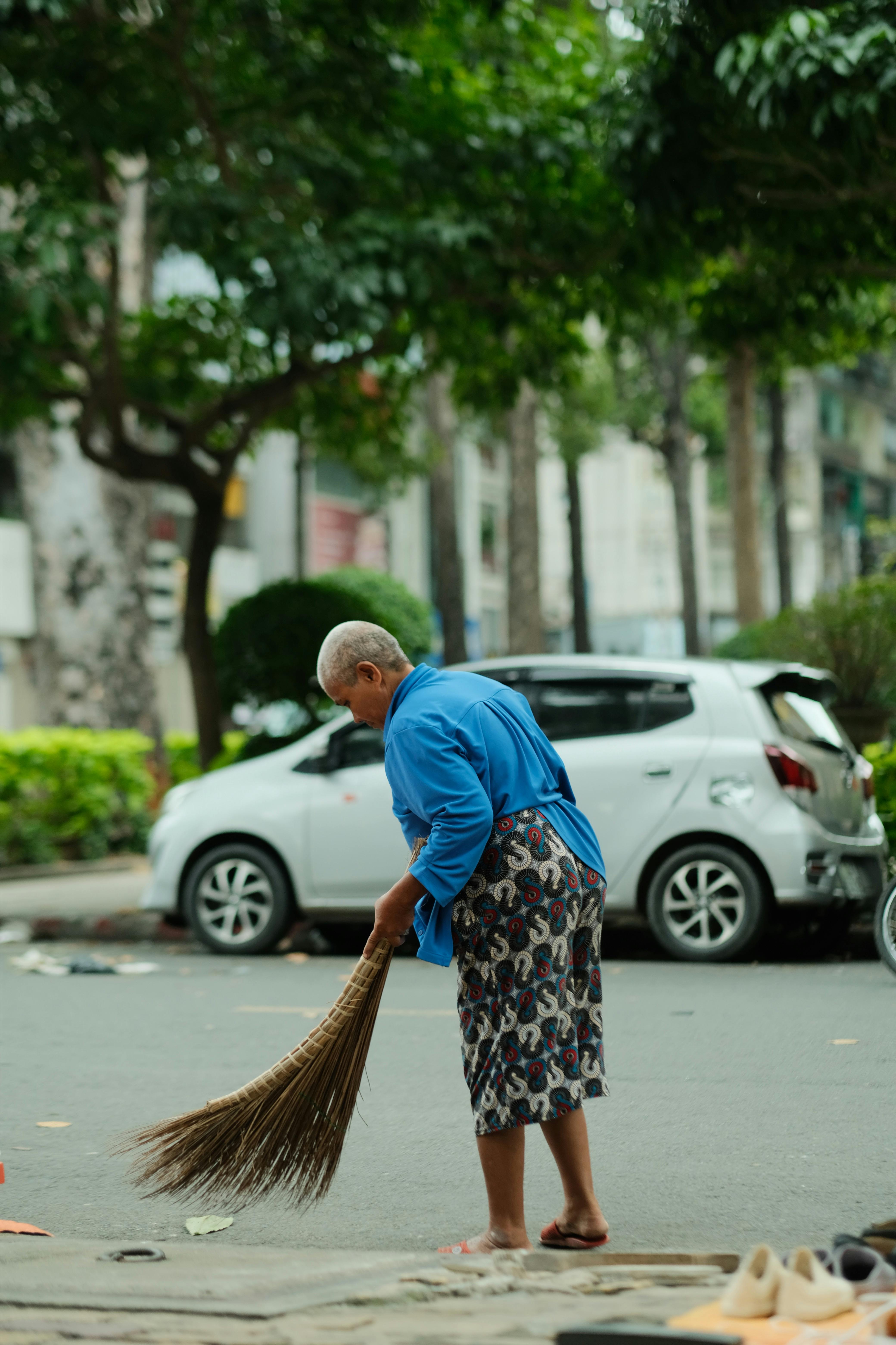 A Woman Sweeping the Road Side · Free Stock Photo