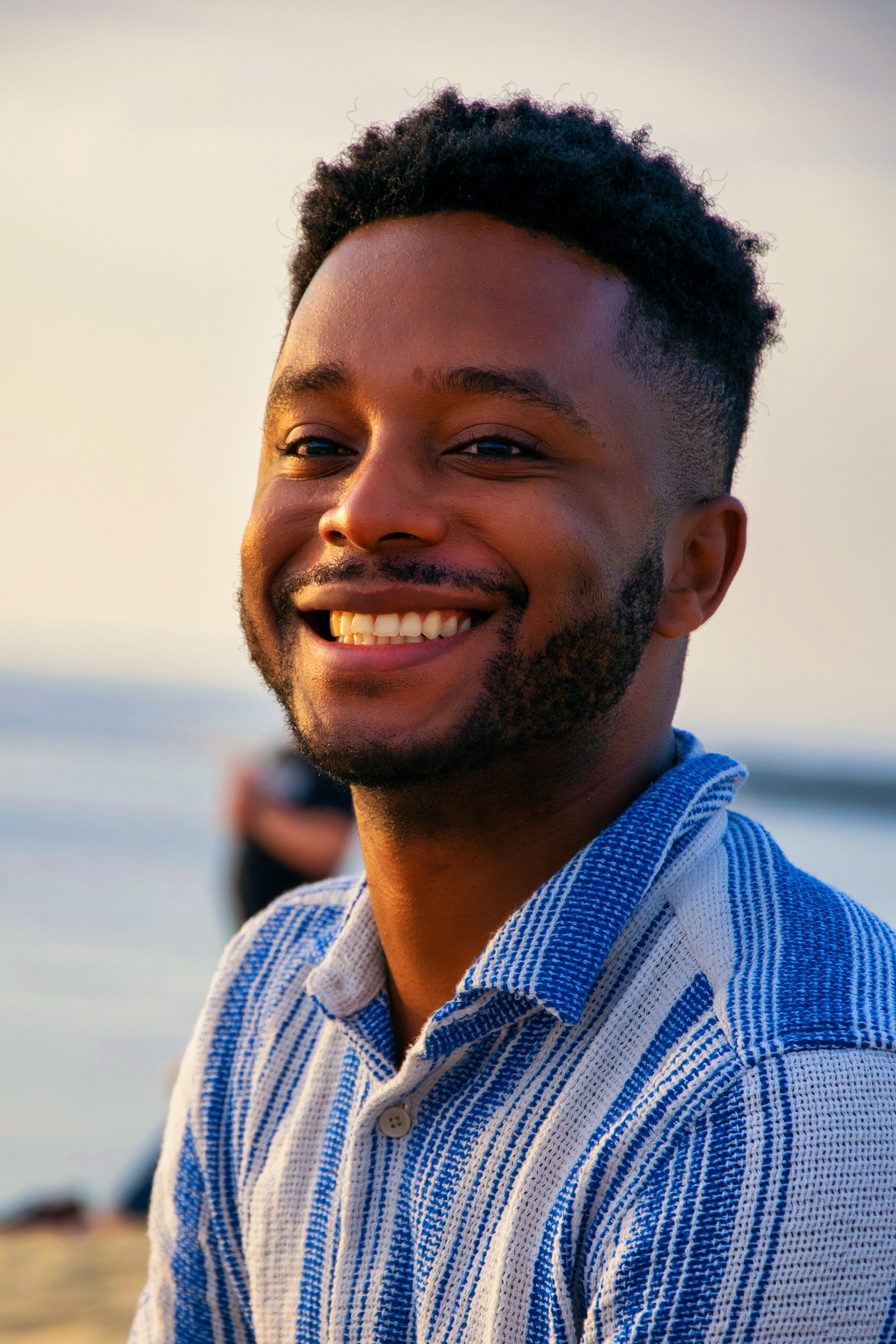 A Bearded Man in Striped Polo Shirt Smiling · Free Stock Photo