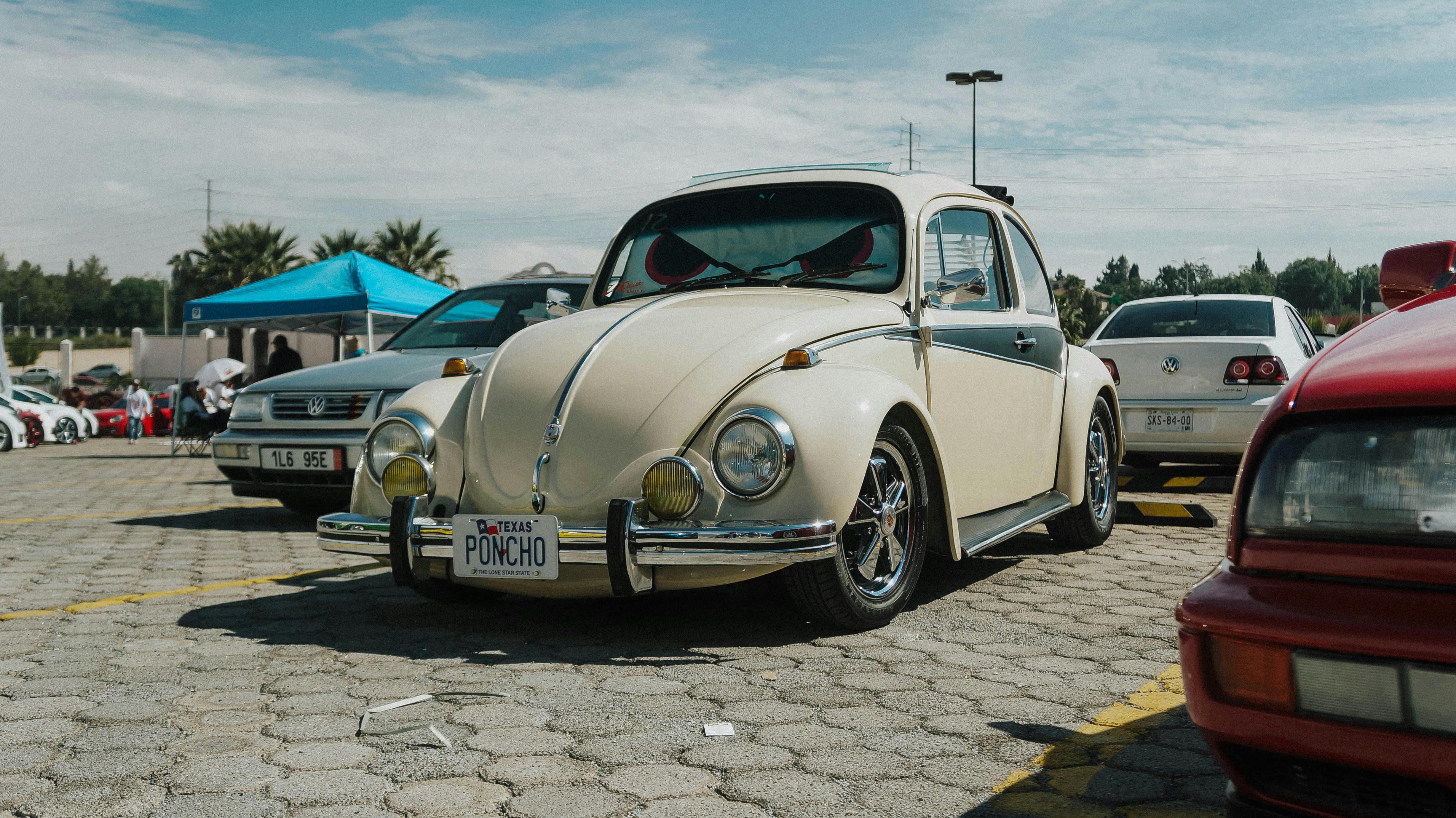 White Volkswagen Beetle Parked on Stone Pavement · Free Stock Photo