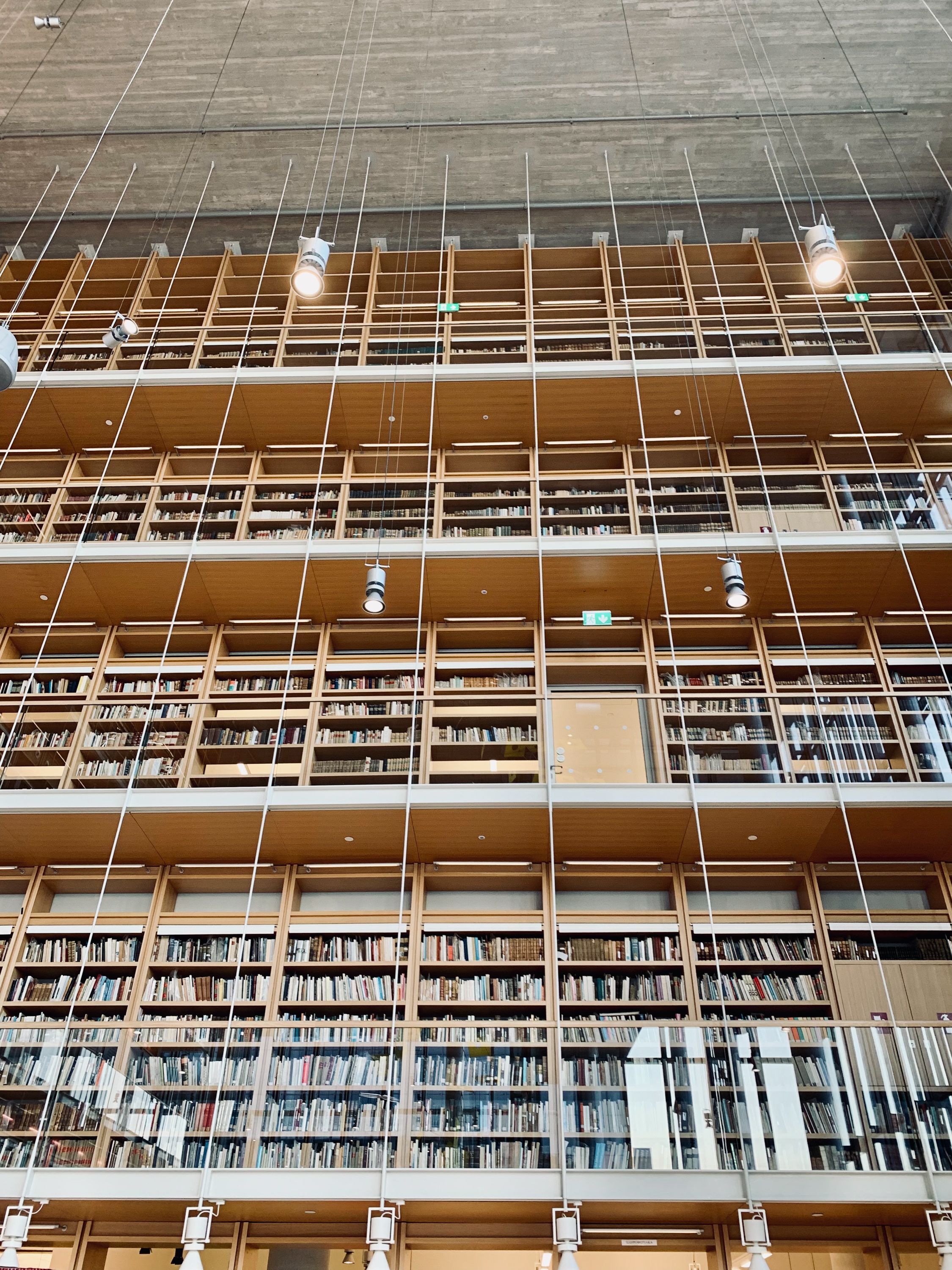 Modern Library Interior with Tall Bookshelves · Free Stock Photo
