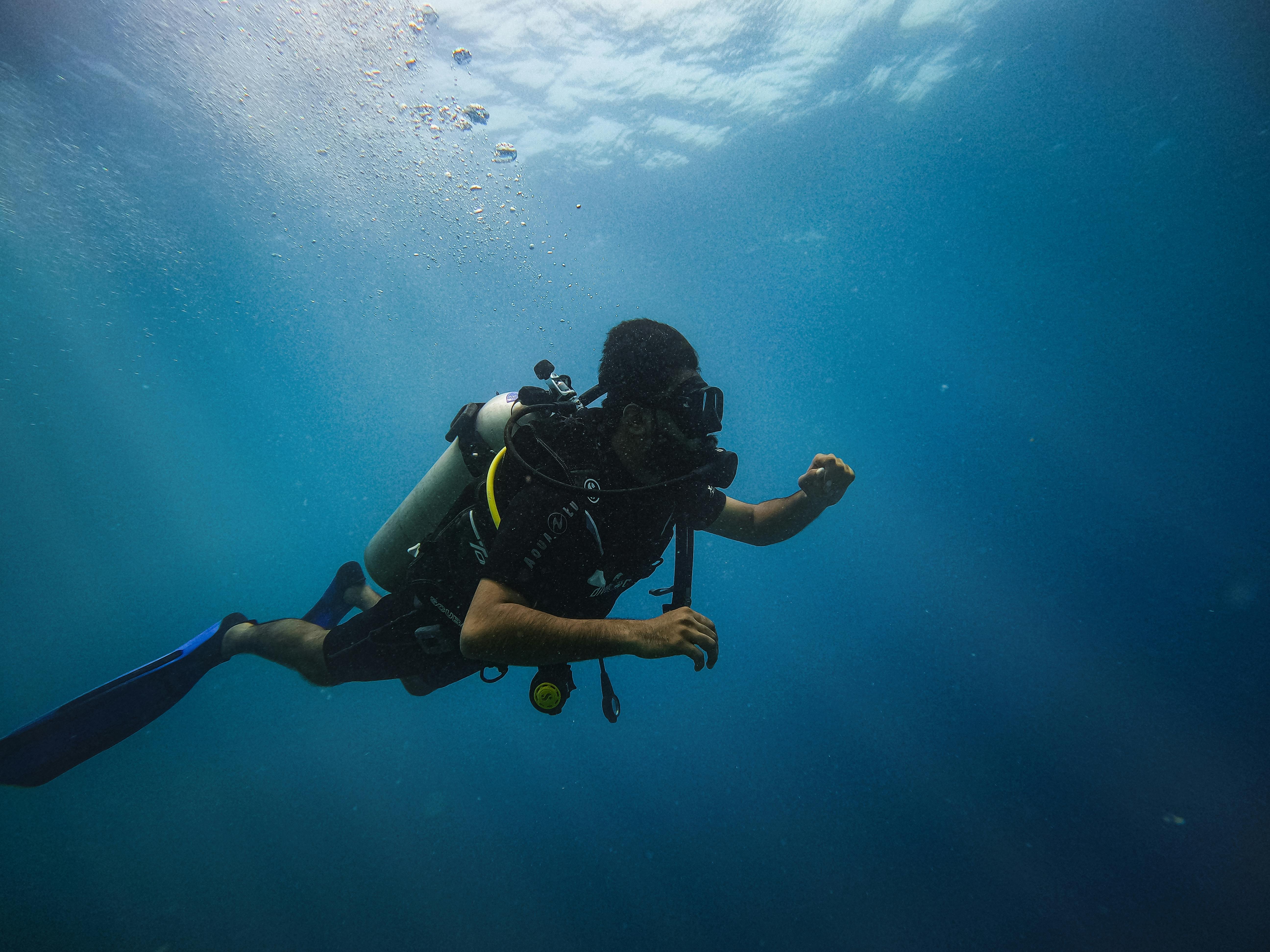 Photography of Person Swimming Under Water · Free Stock Photo