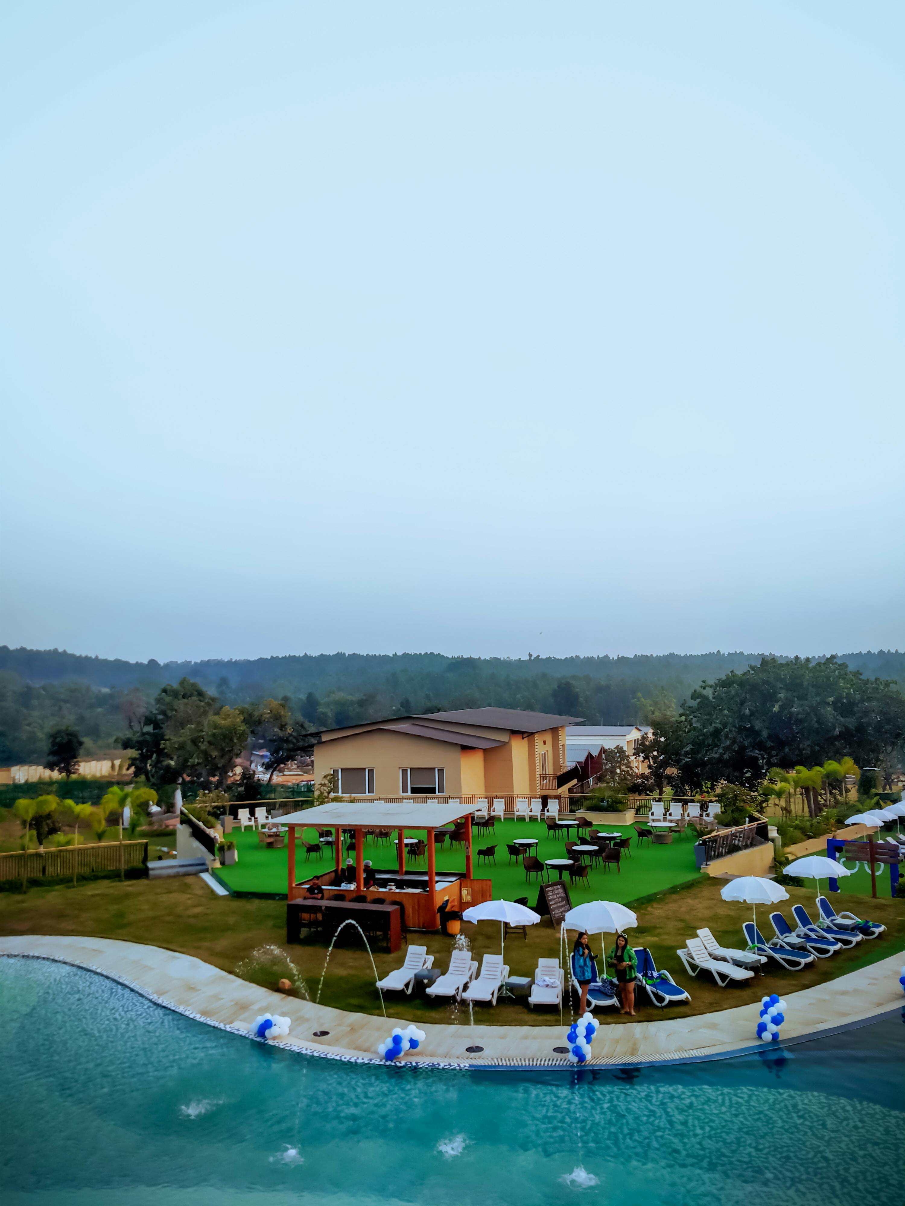 Aerial View of Sun Loungers next to a Swimming Pool at Kushal Palli ...