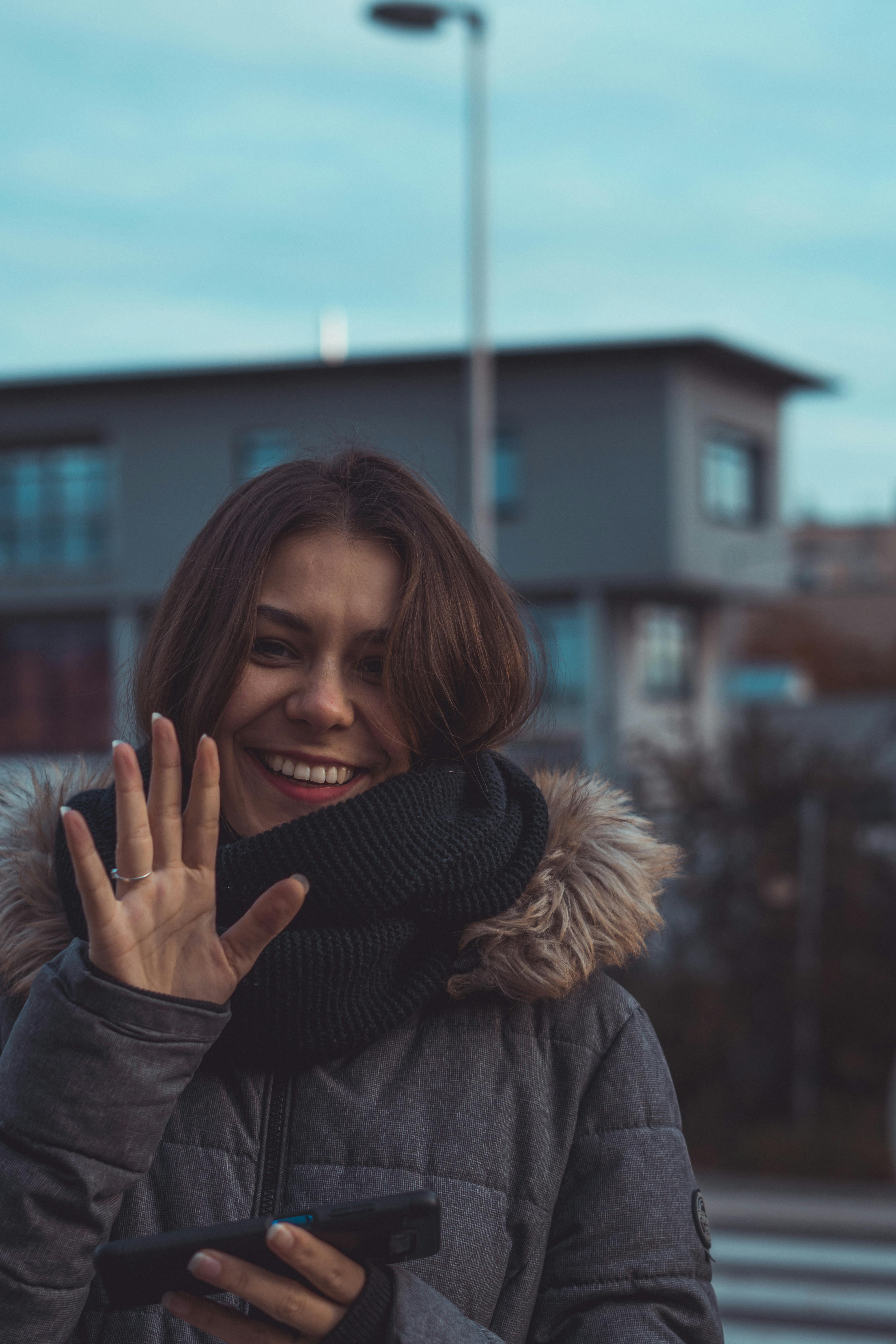 A Woman in Black Fur Coat Holding A Loaf of Bread · Free Stock Photo