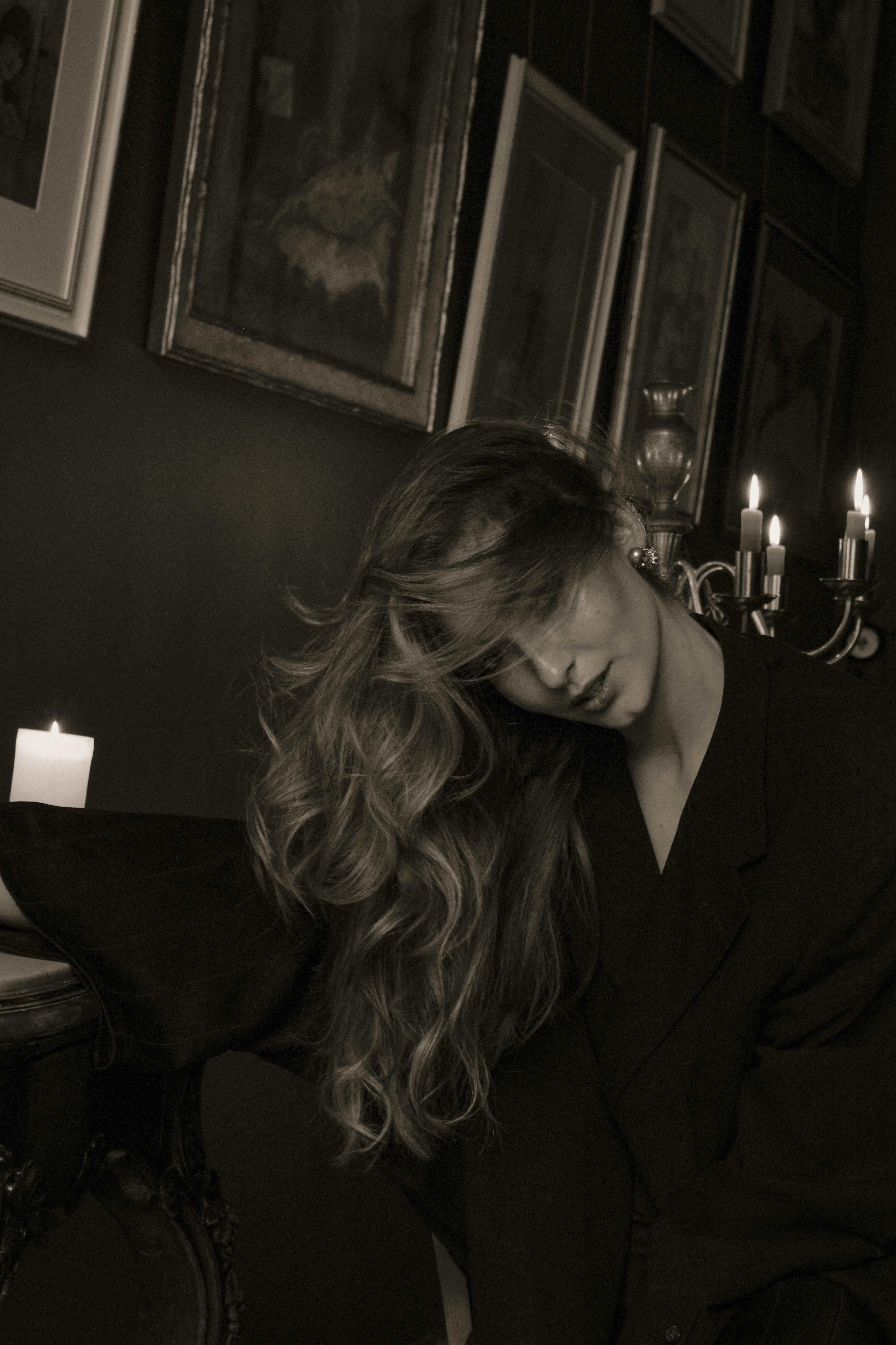 Woman Posing near Paintings on Wall · Free Stock Photo