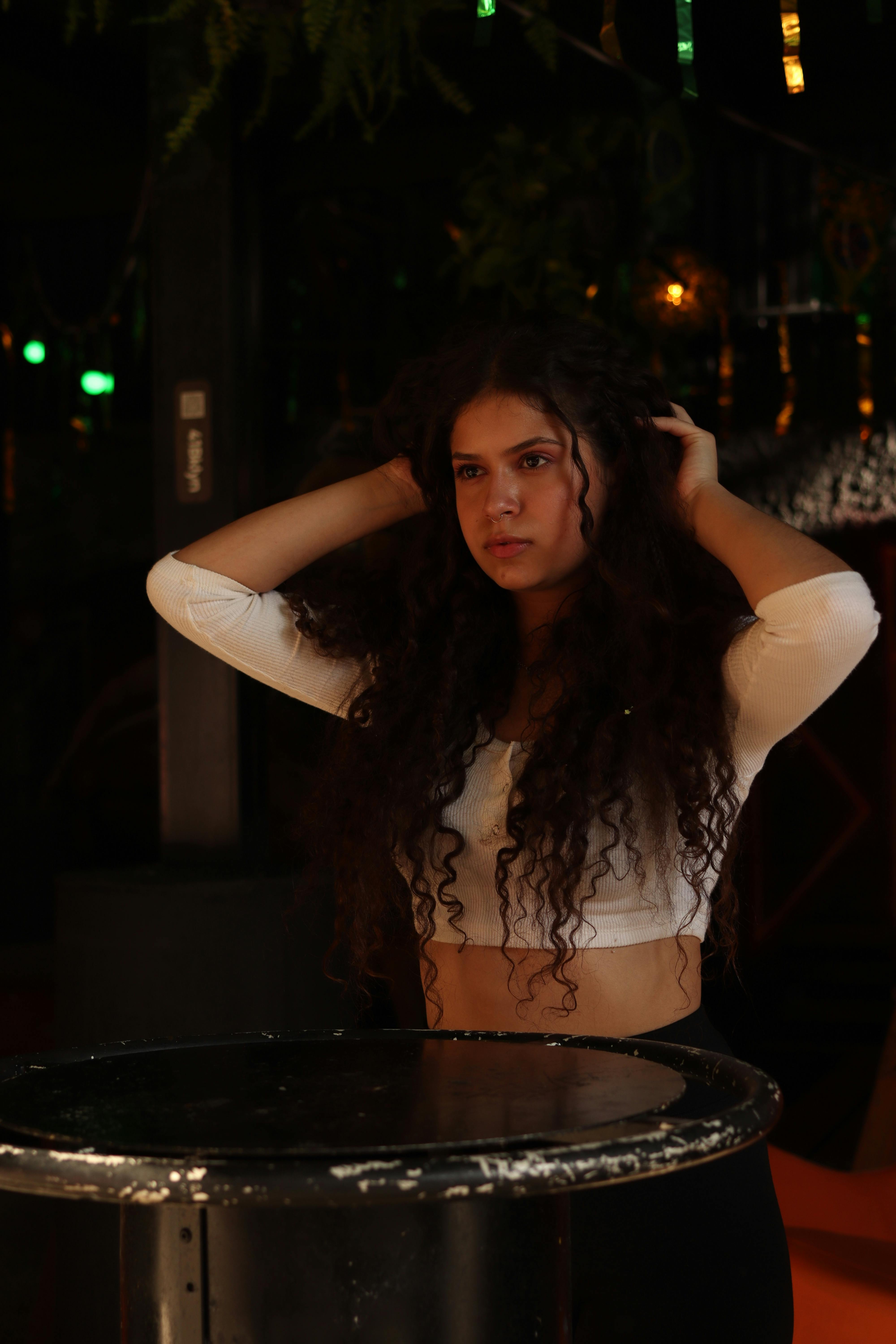 Young Woman Looking at the Back of Her Hand · Free Stock Photo