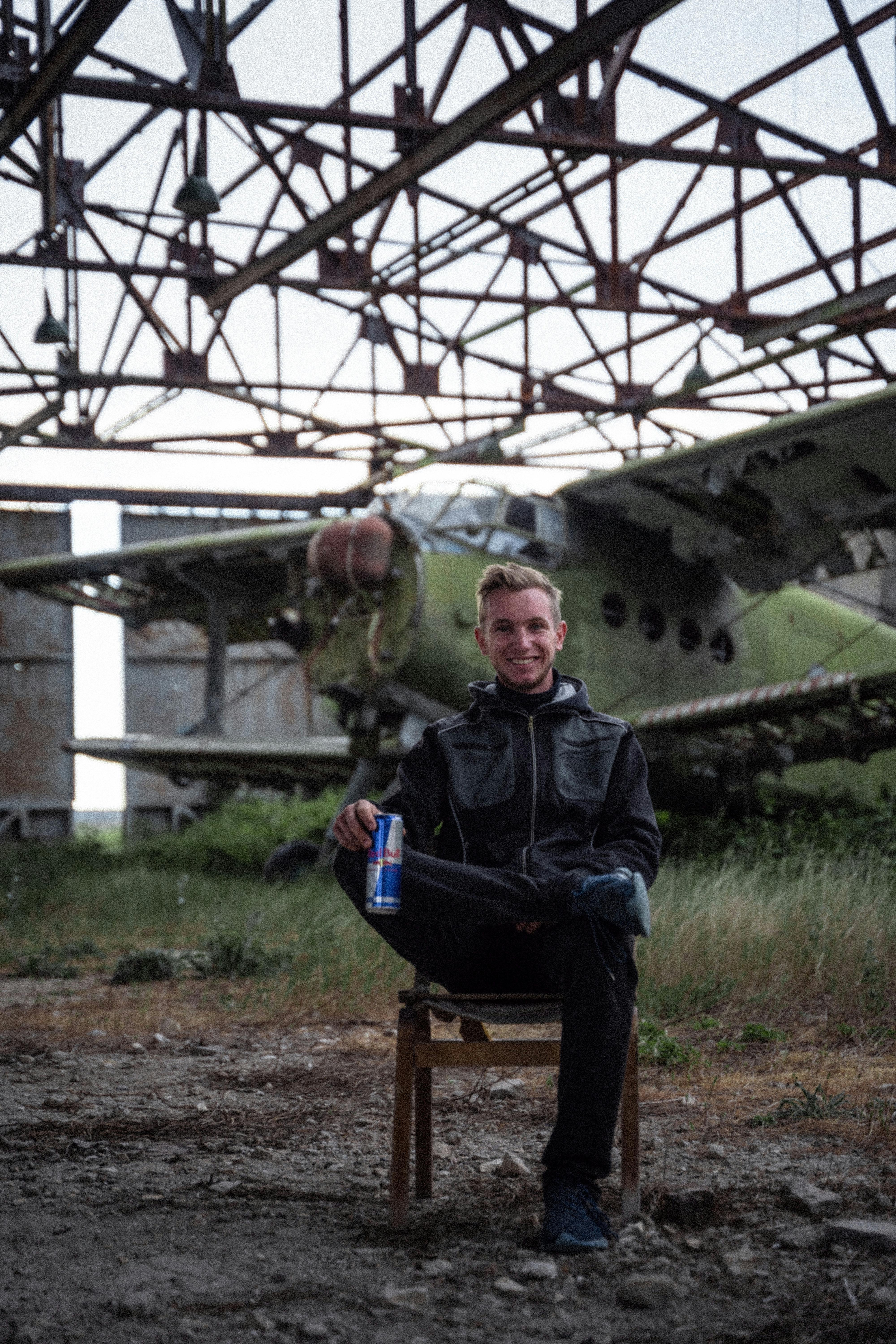Man Sitting with Red Bull Energy Drink and Biplane behind · Free Stock ...
