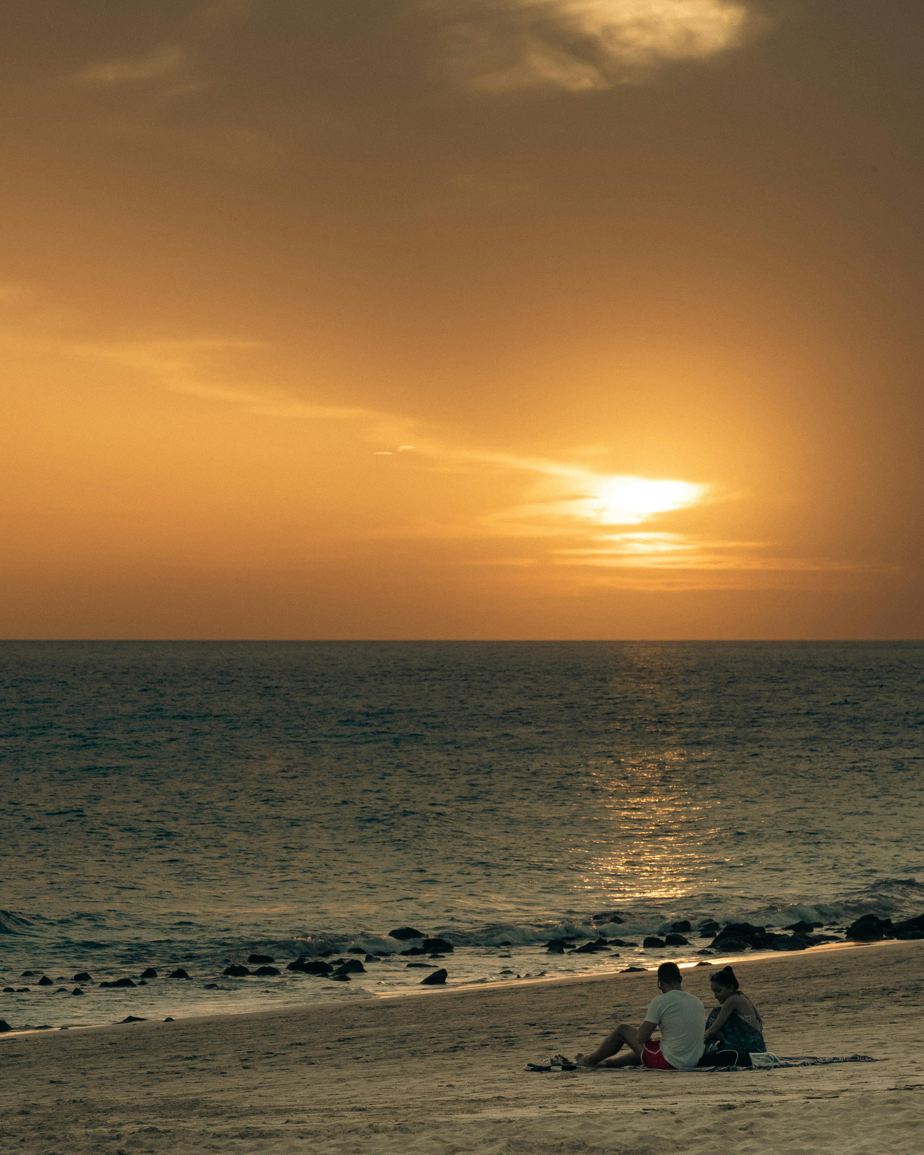 People Sitting on a Beach During Sunset · Free Stock Photo