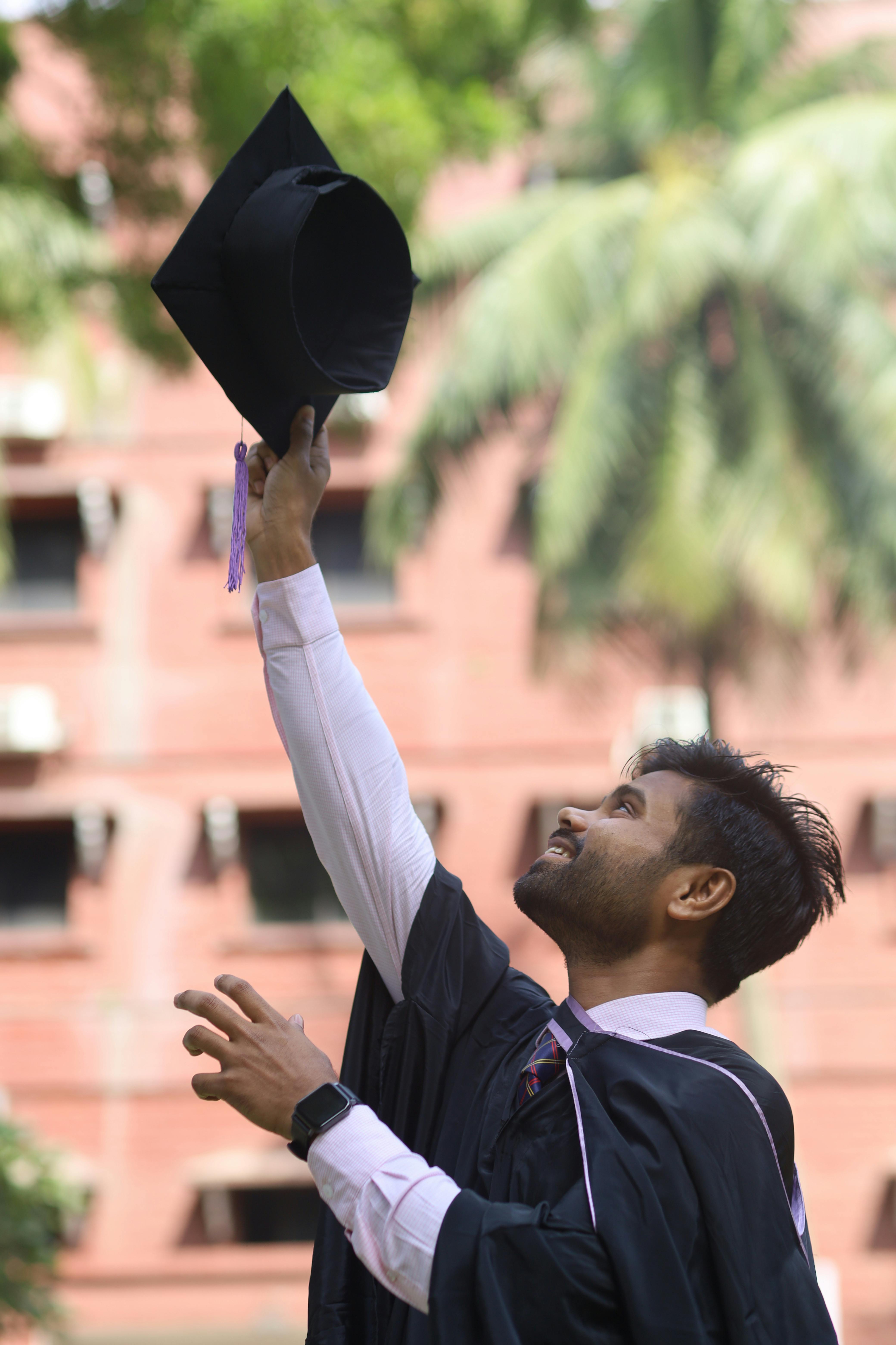 Man Tossing Graduation Cap · Free Stock Photo