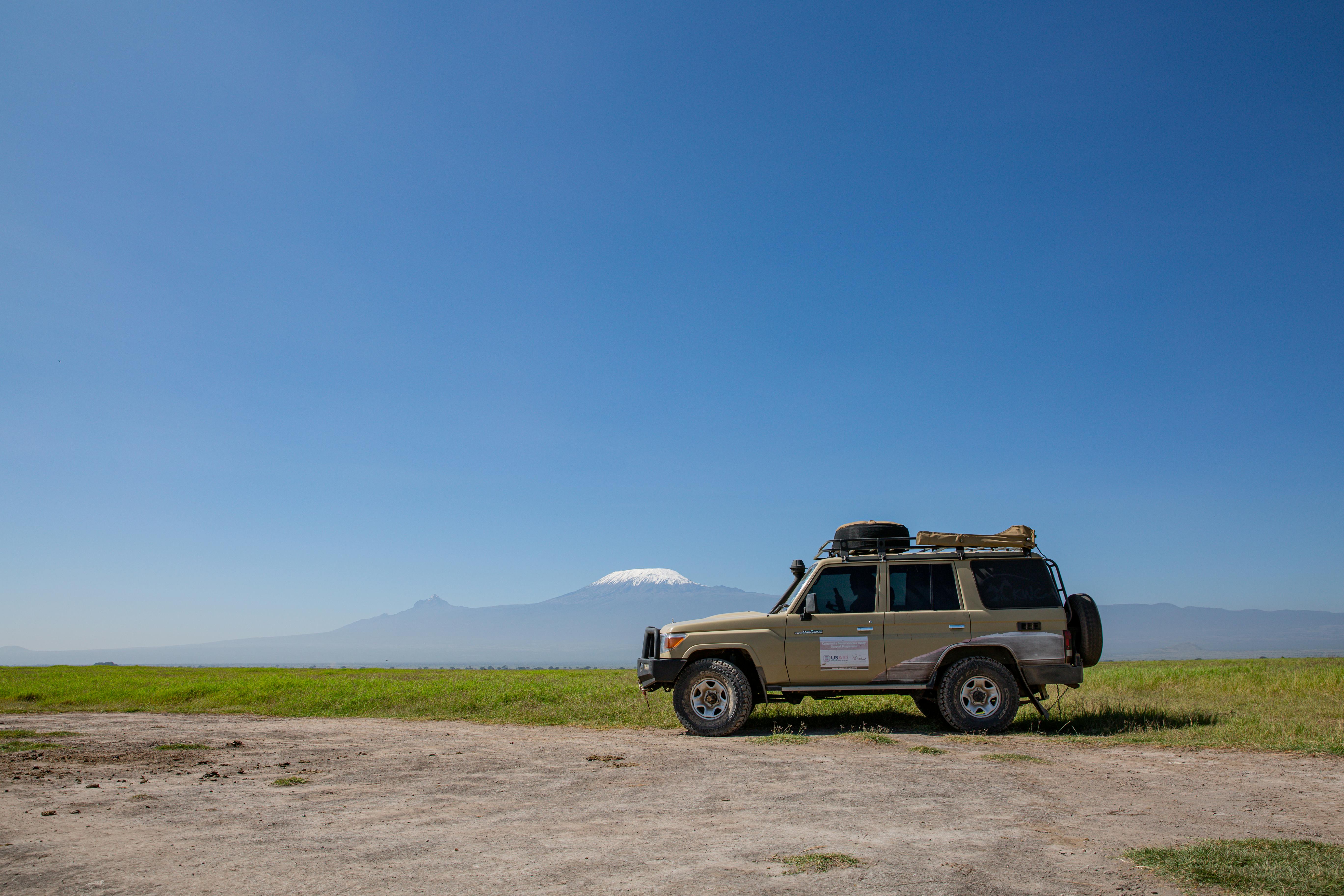 Brown Vehicle Parked on Grassland · Free Stock Photo