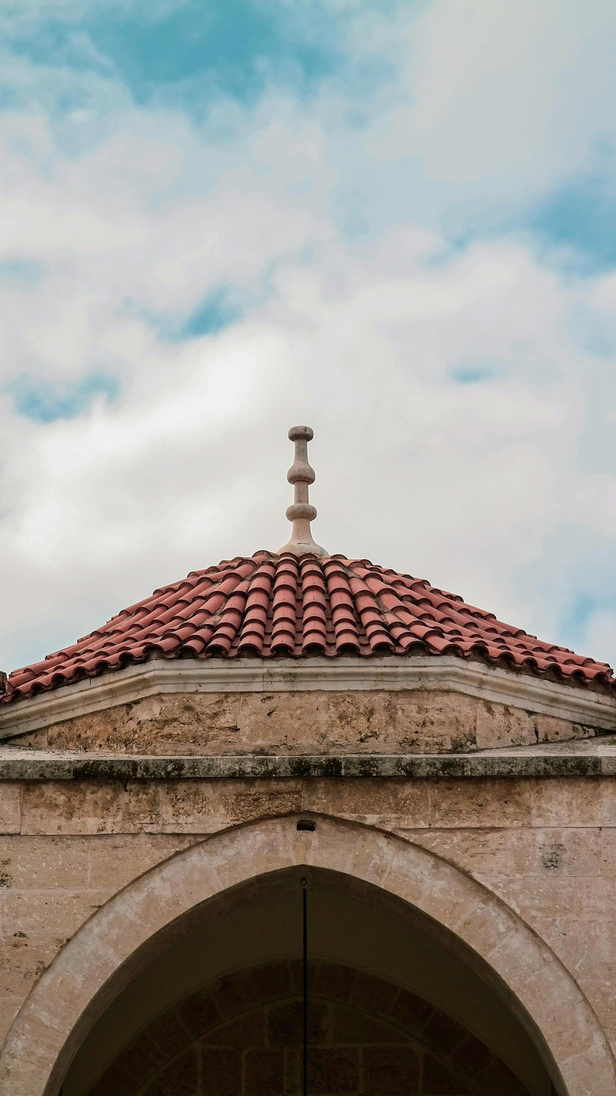 Symmetrical View of an Architecture with an Arch and a Tiled Roof ...