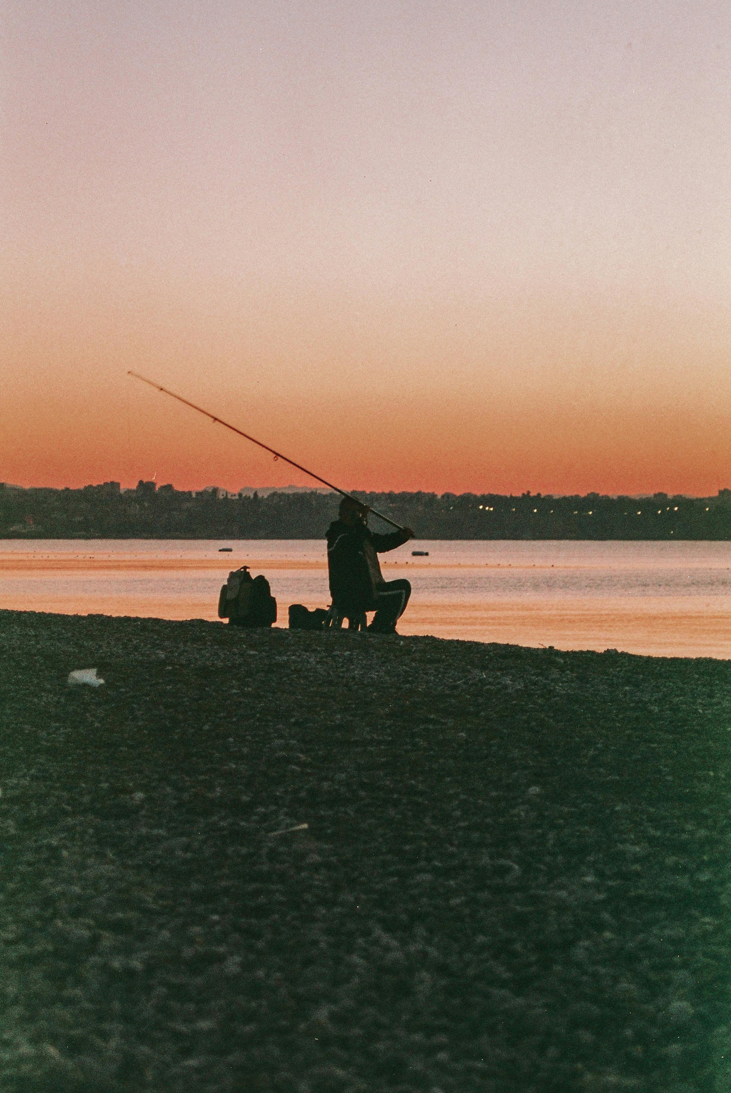 Man Fishing Alone During Sunset · Free Stock Photo