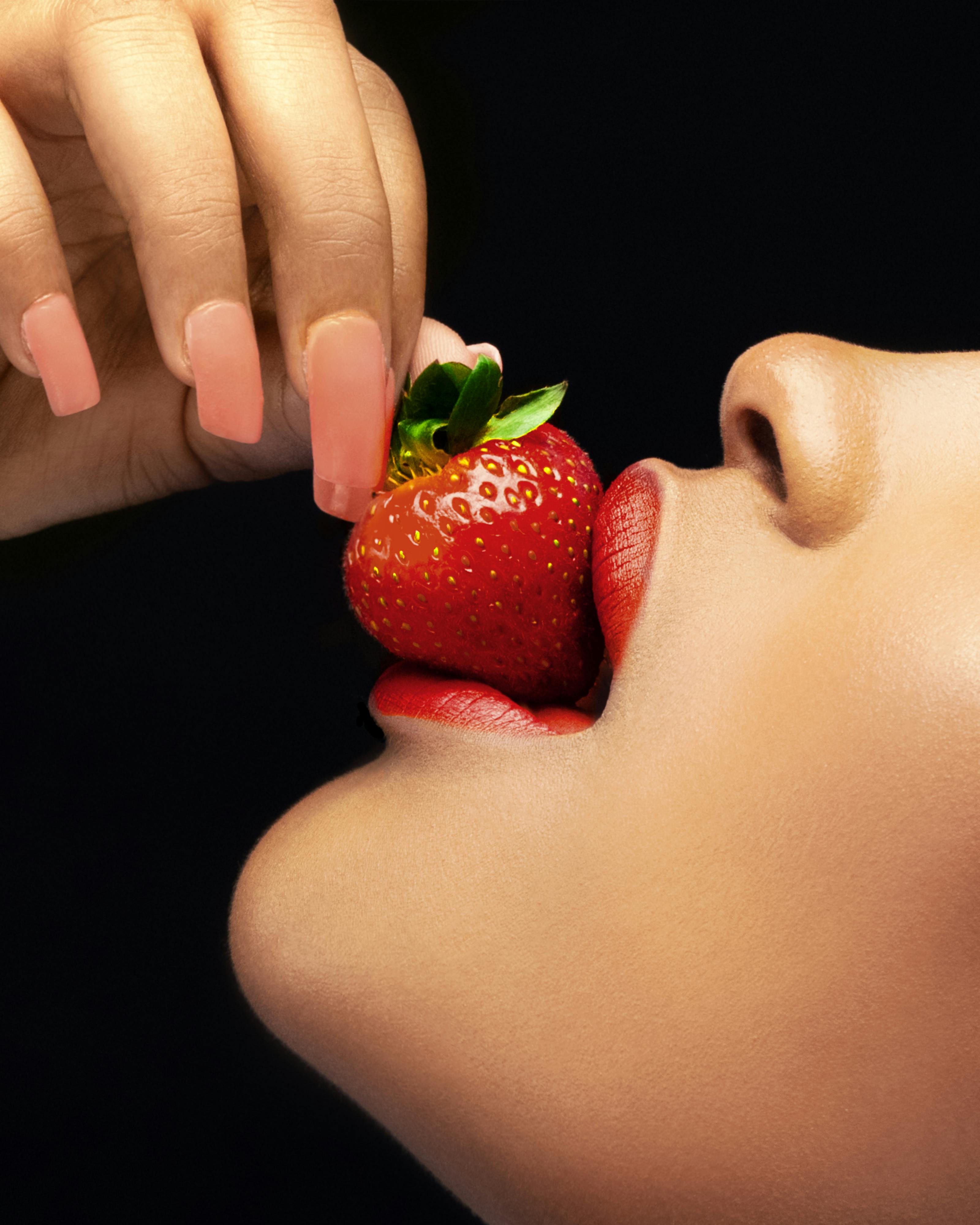 A Close-Up Shot of a Woman with Red Lips Eating a Strawberry · Free ...