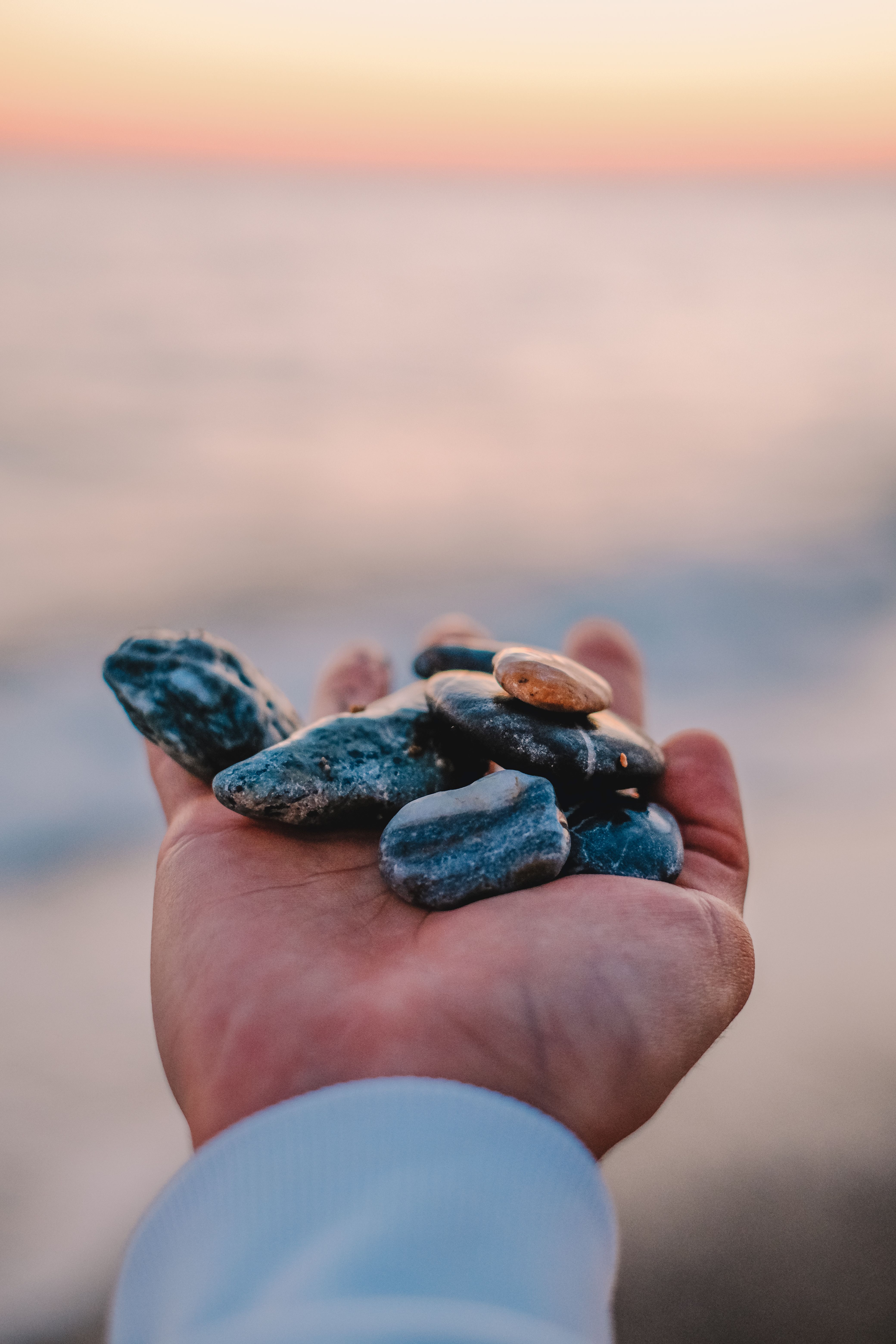Hand Holding Pebbles · Free Stock Photo