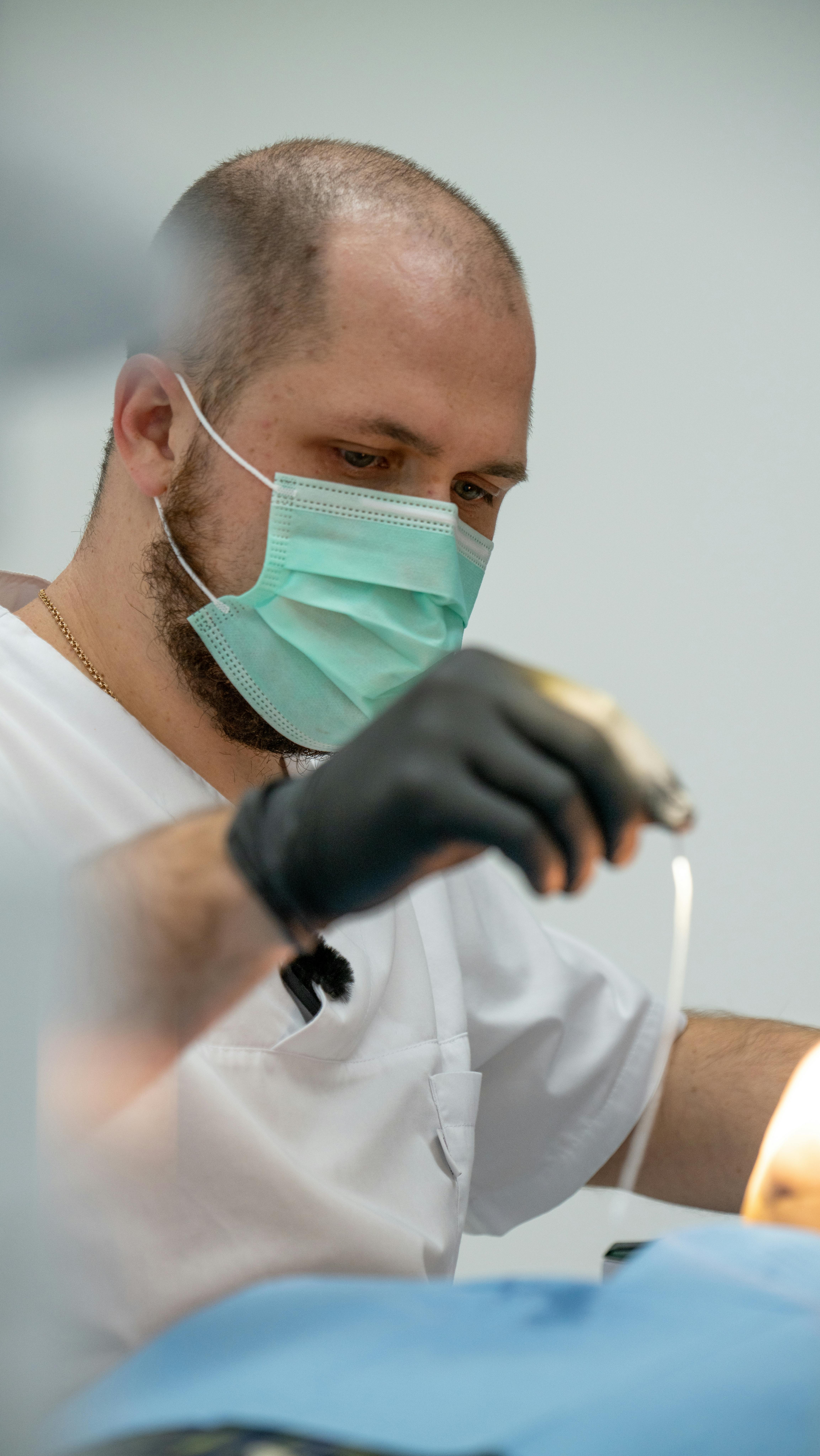 Close-Up Shot of a Man Wearing Surgical Mask · Free Stock Photo