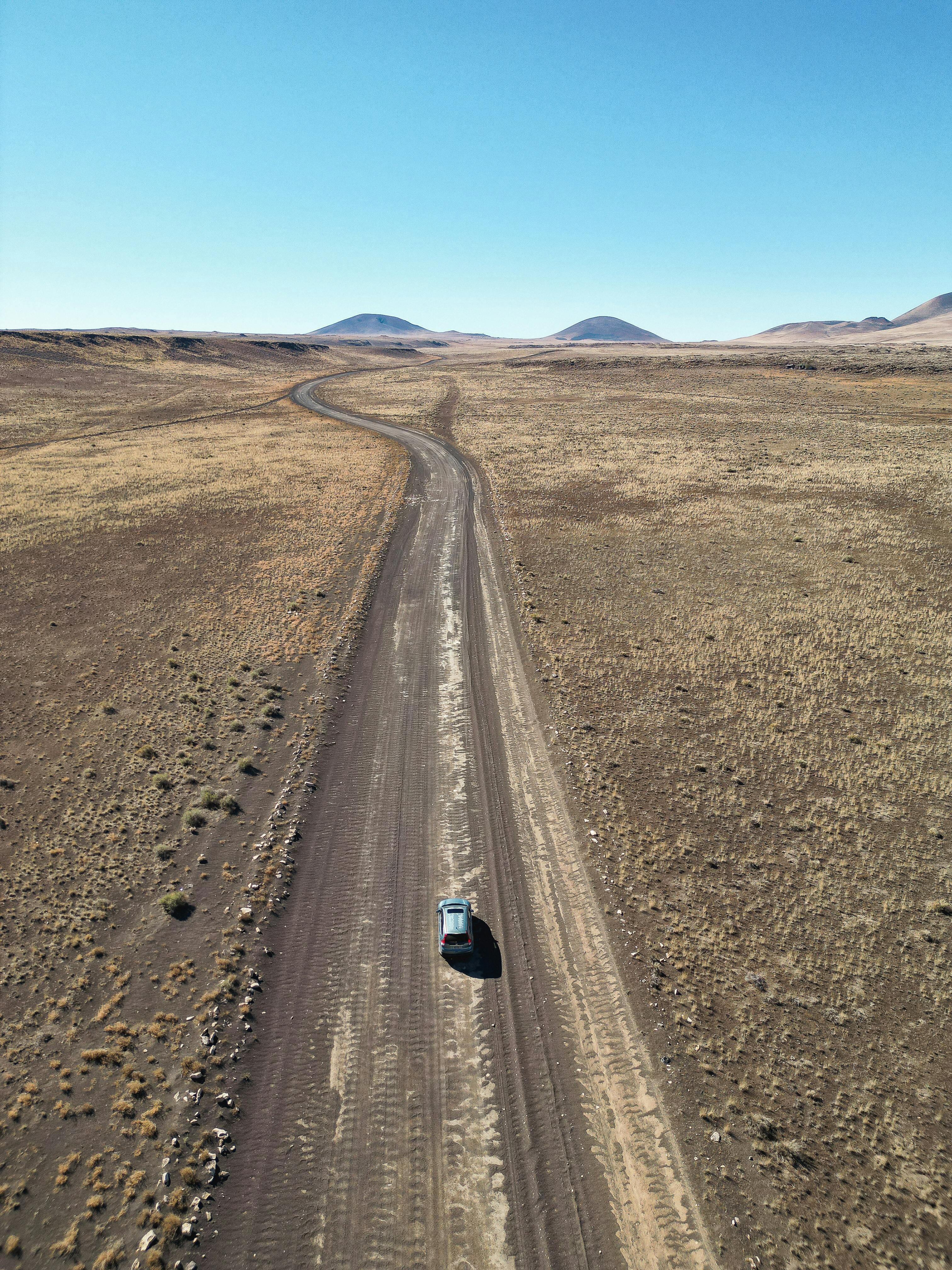 High Angle Shot of Car on Dirt Road · Free Stock Photo