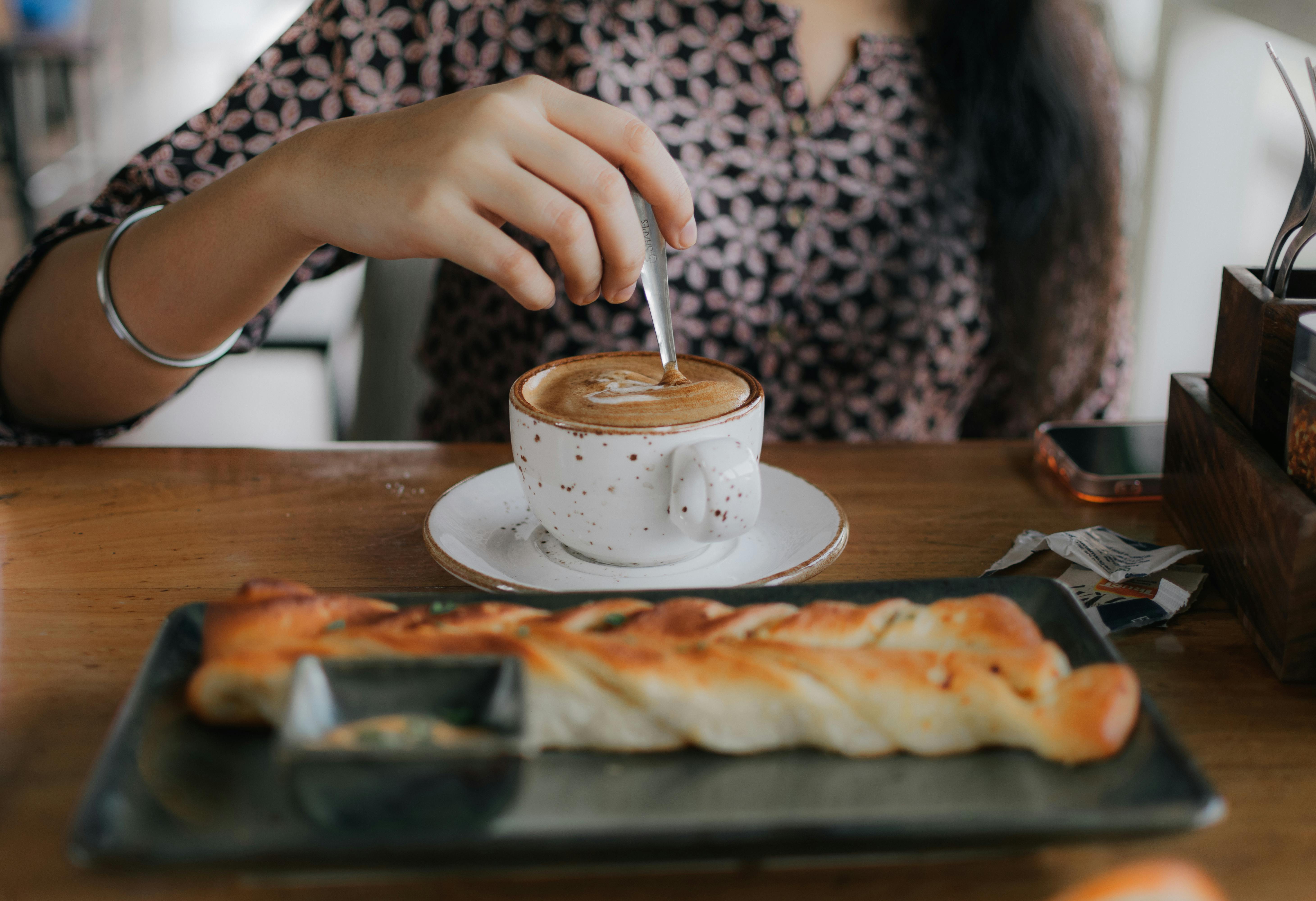 Woman Drinking Coffee in Cafe · Free Stock Photo