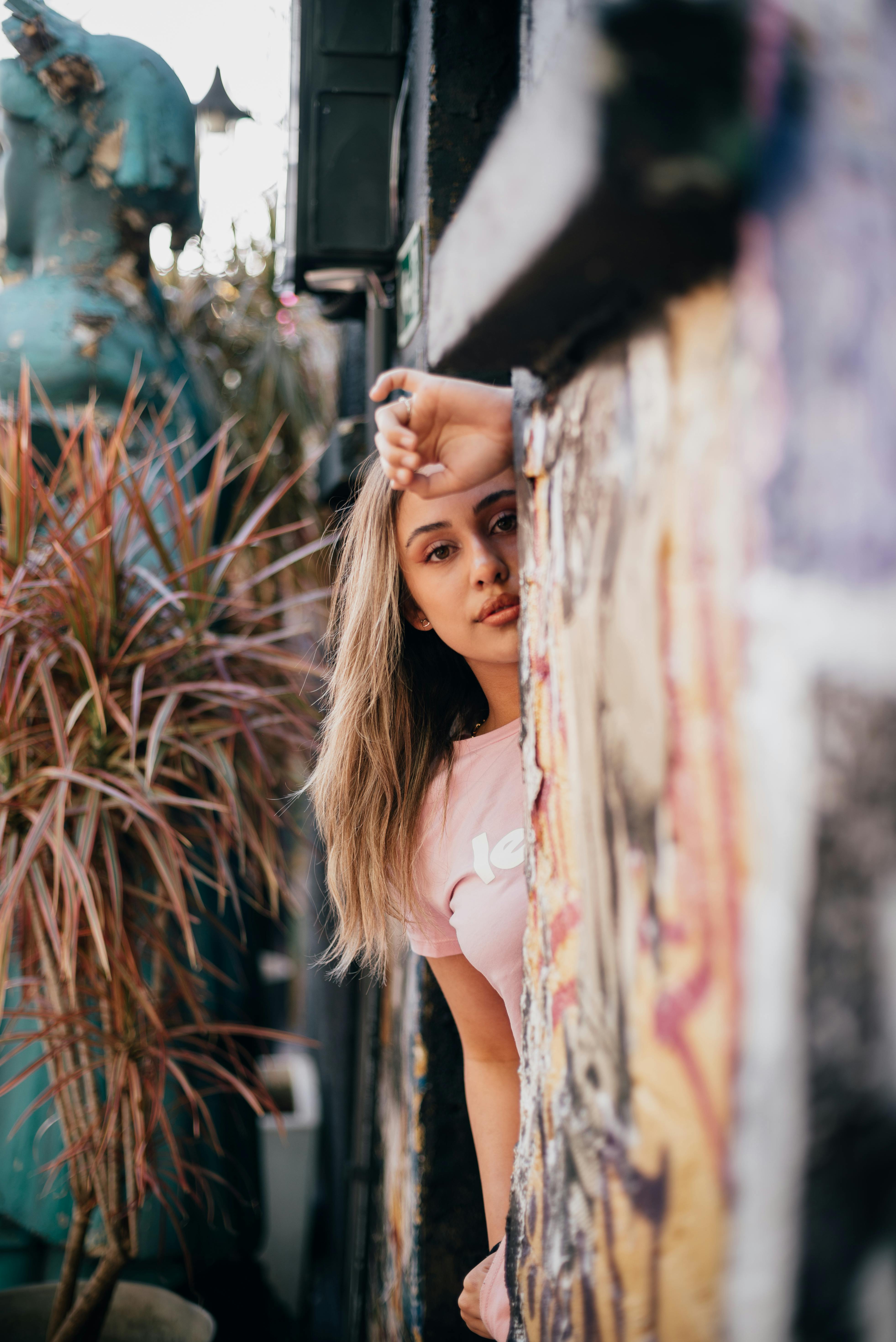 Woman Leaning Off Building Rim · Free Stock Photo