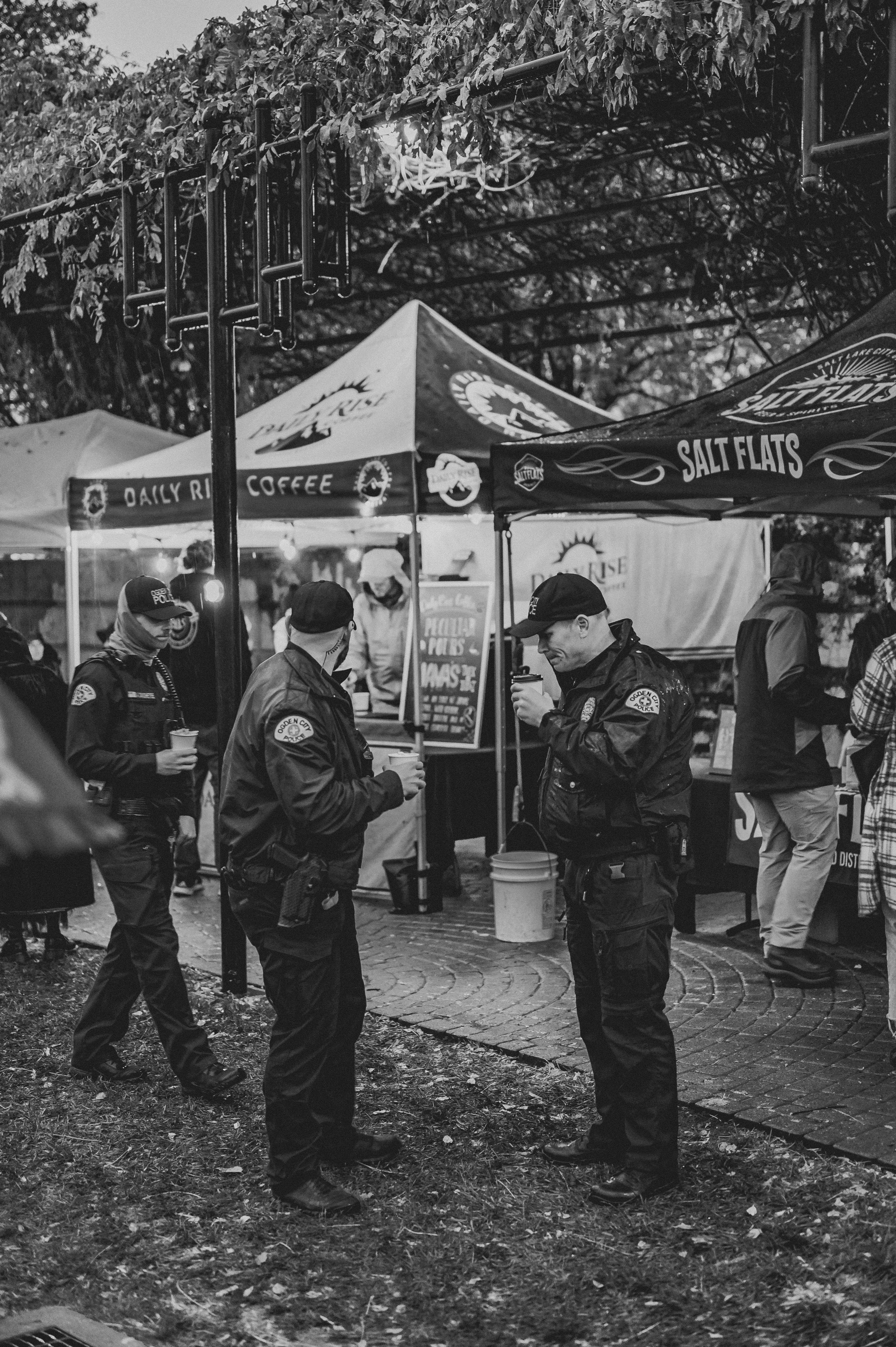 A Grayscale Photo of a Woman Drinking Coffee while Sitting on the ...