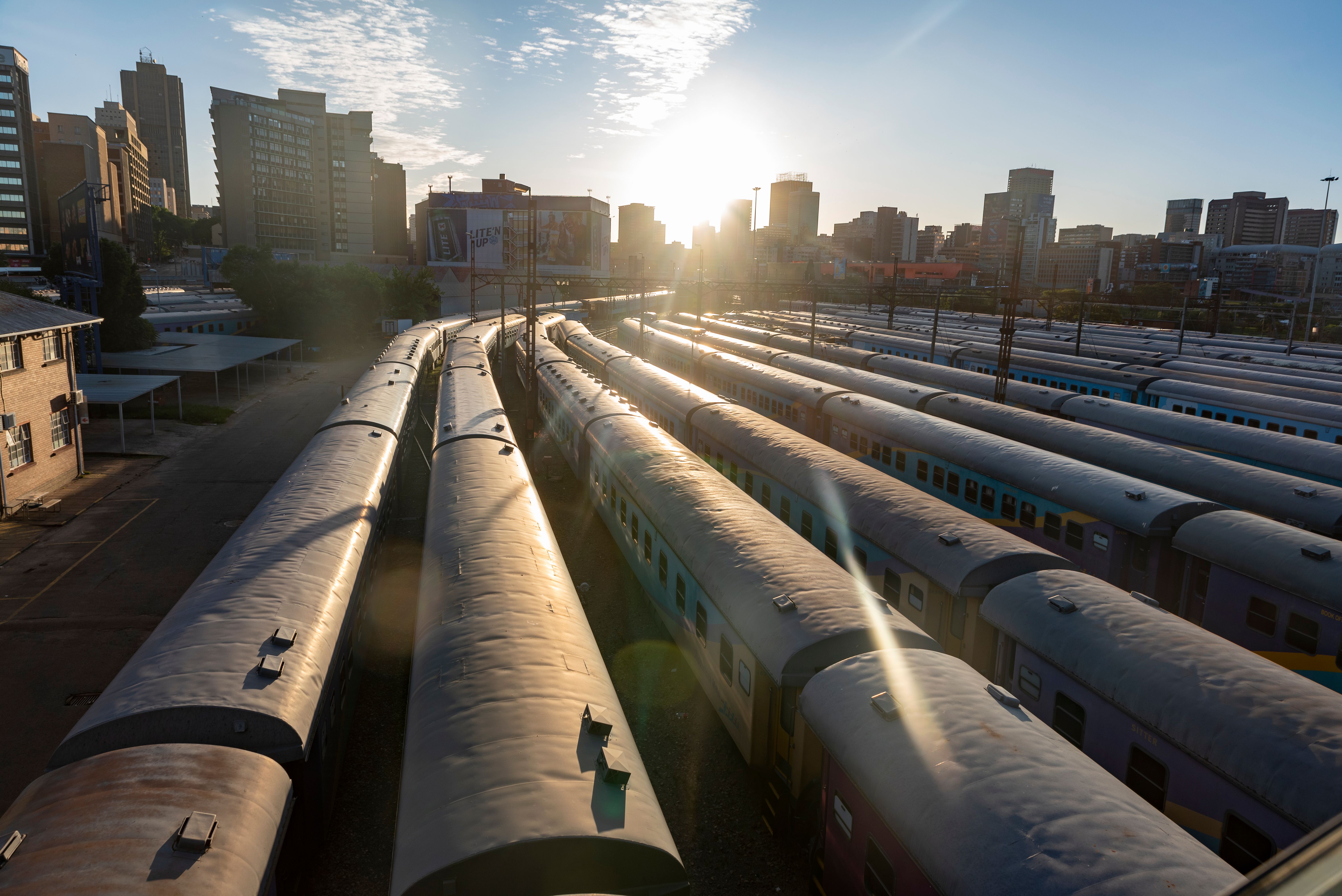 Gray Trains on Train Depot near Buildings · Free Stock Photo