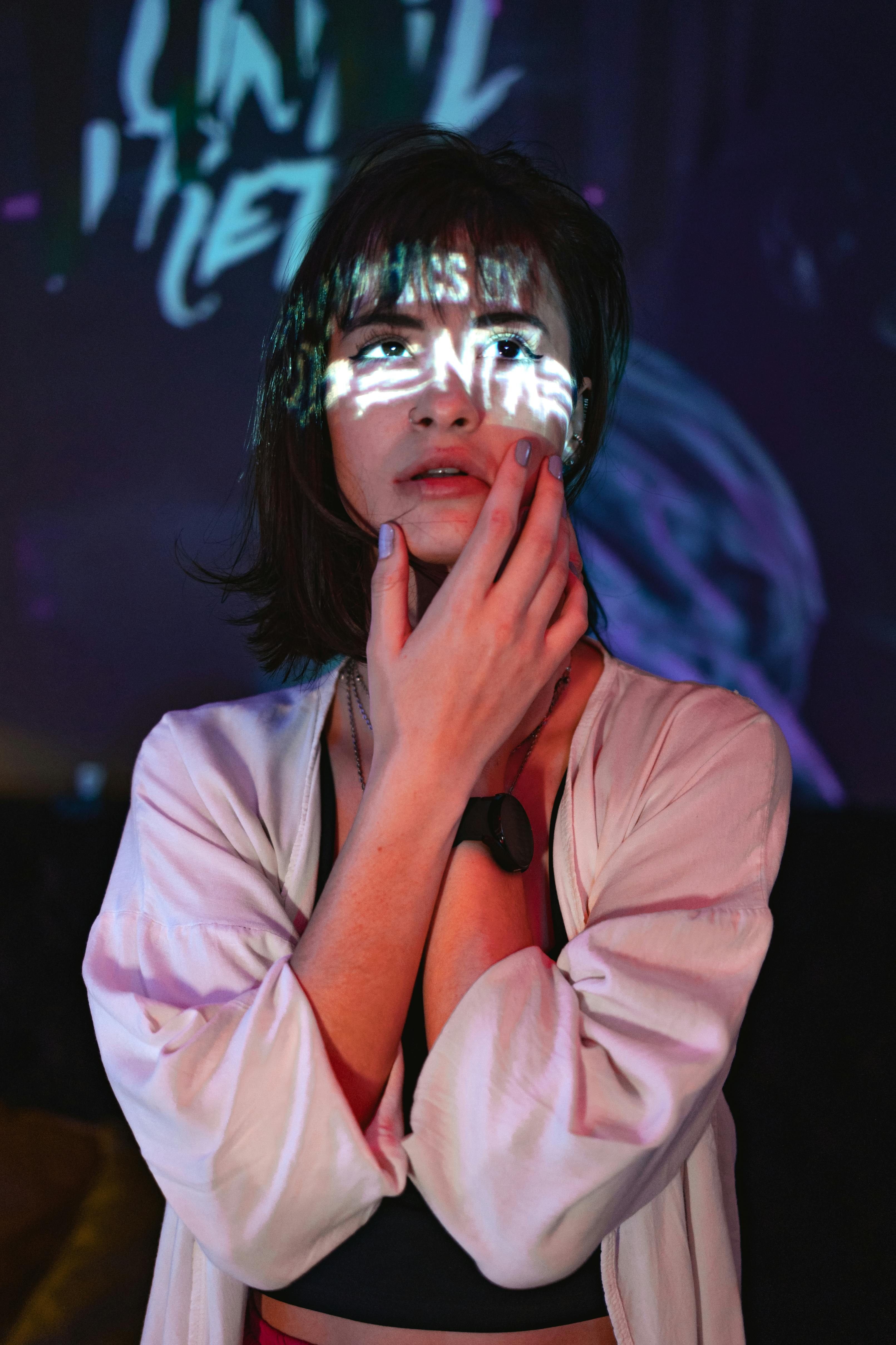 A Woman with Projector Light on her Face · Free Stock Photo