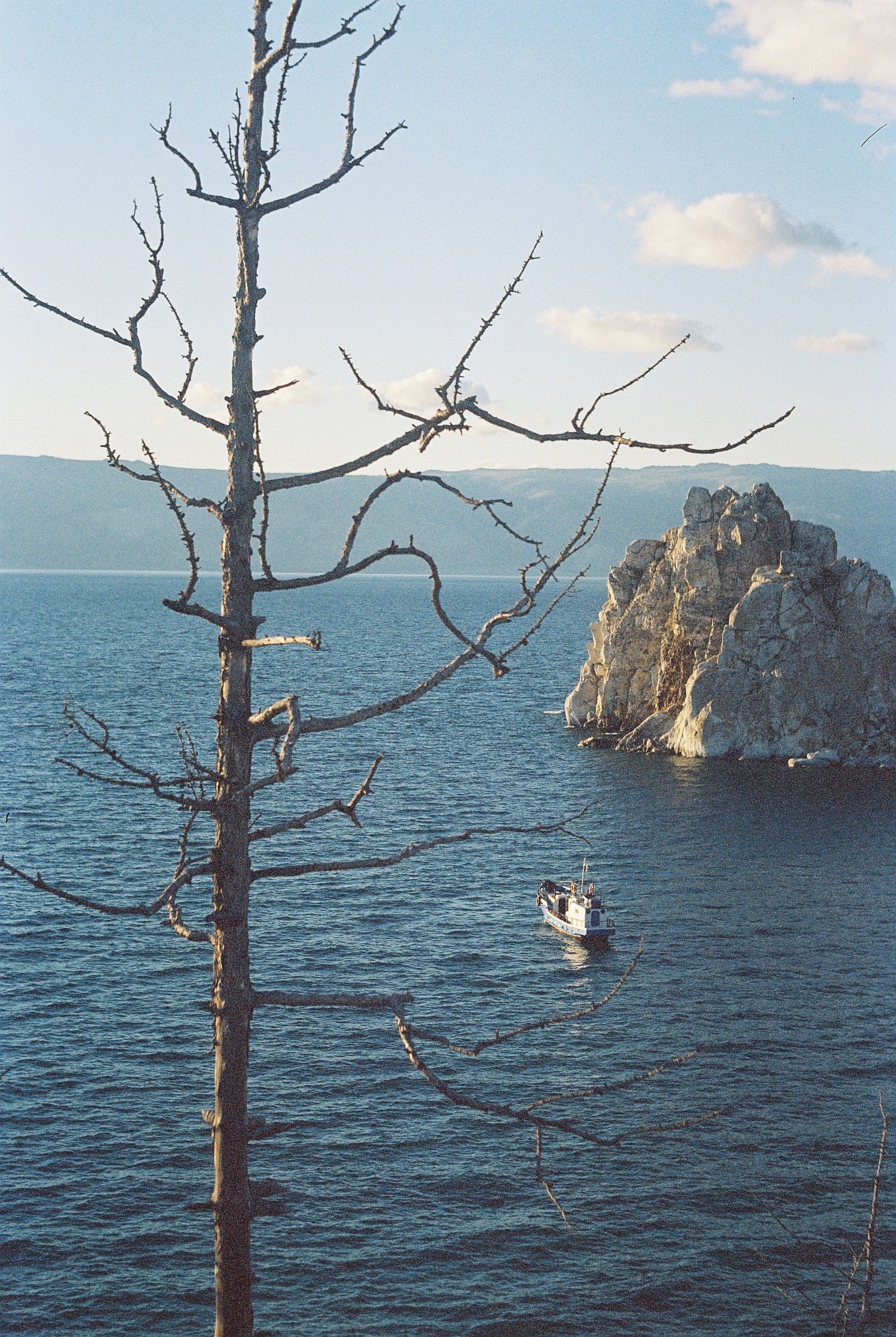 A Boat on Sea Near Rock Formations · Free Stock Photo